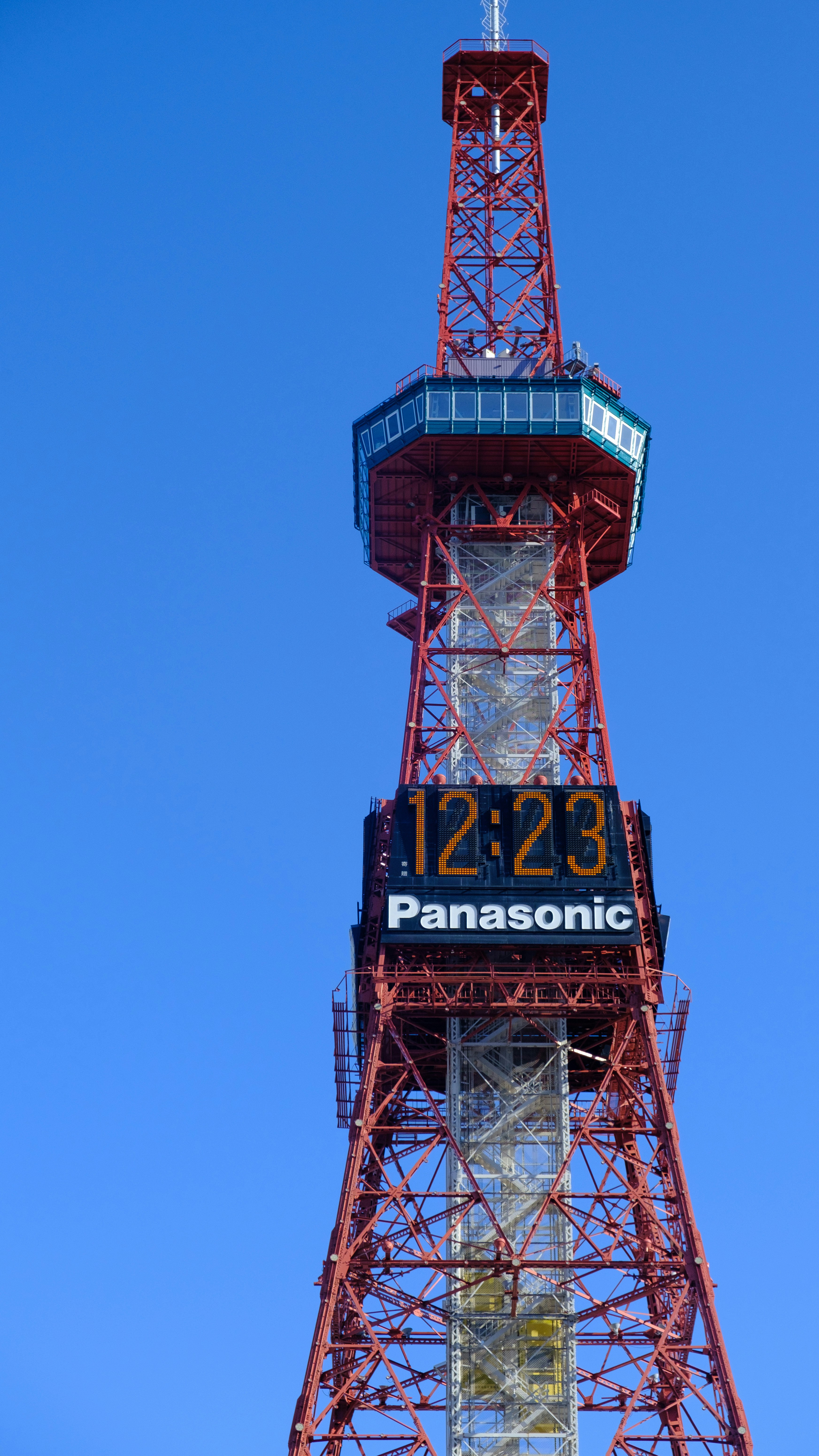 A very tall tower with a clock on it's side