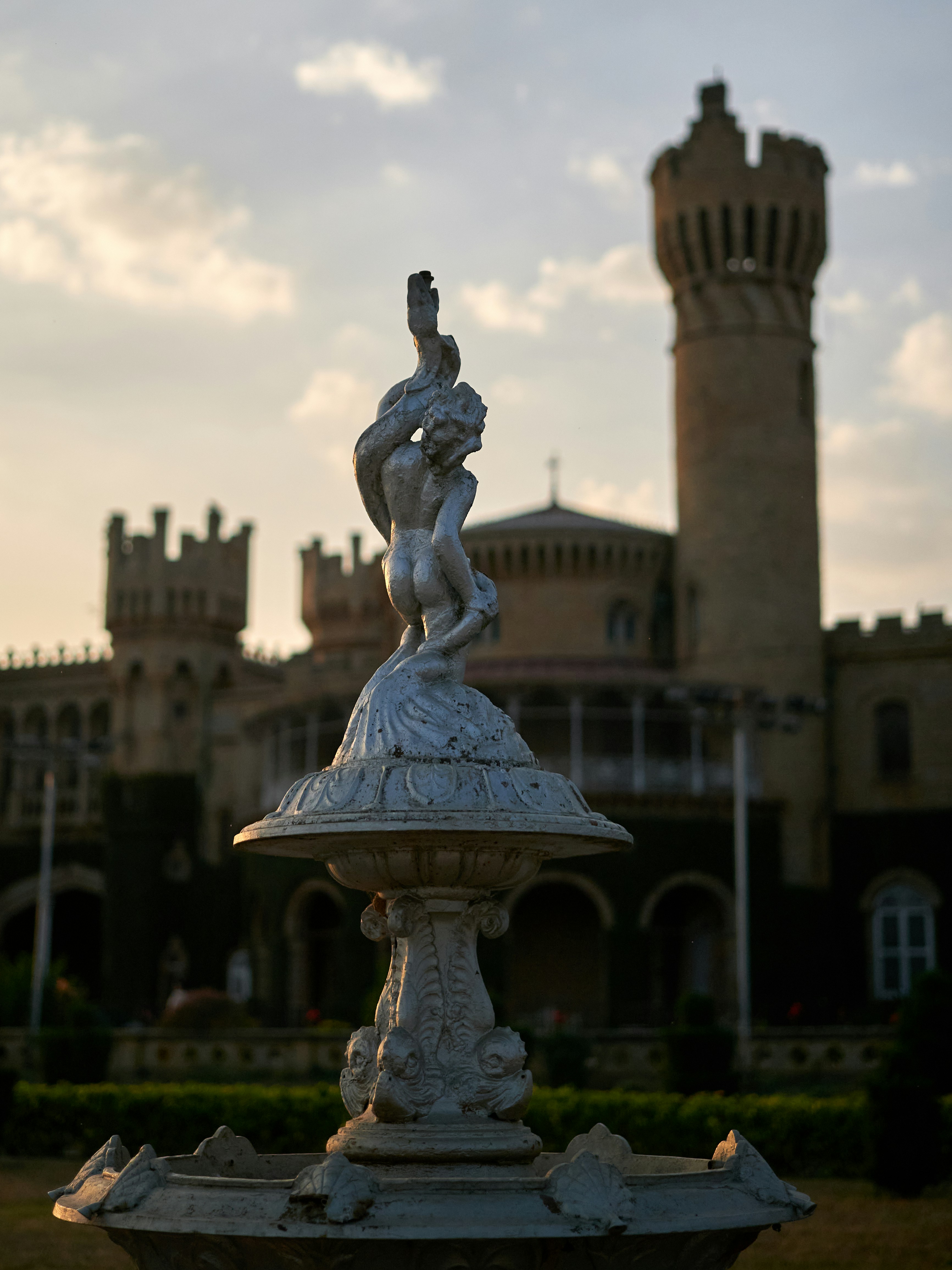 Mermaid on a Tiered Fountain Framed by a Sunset Castle Courtyard