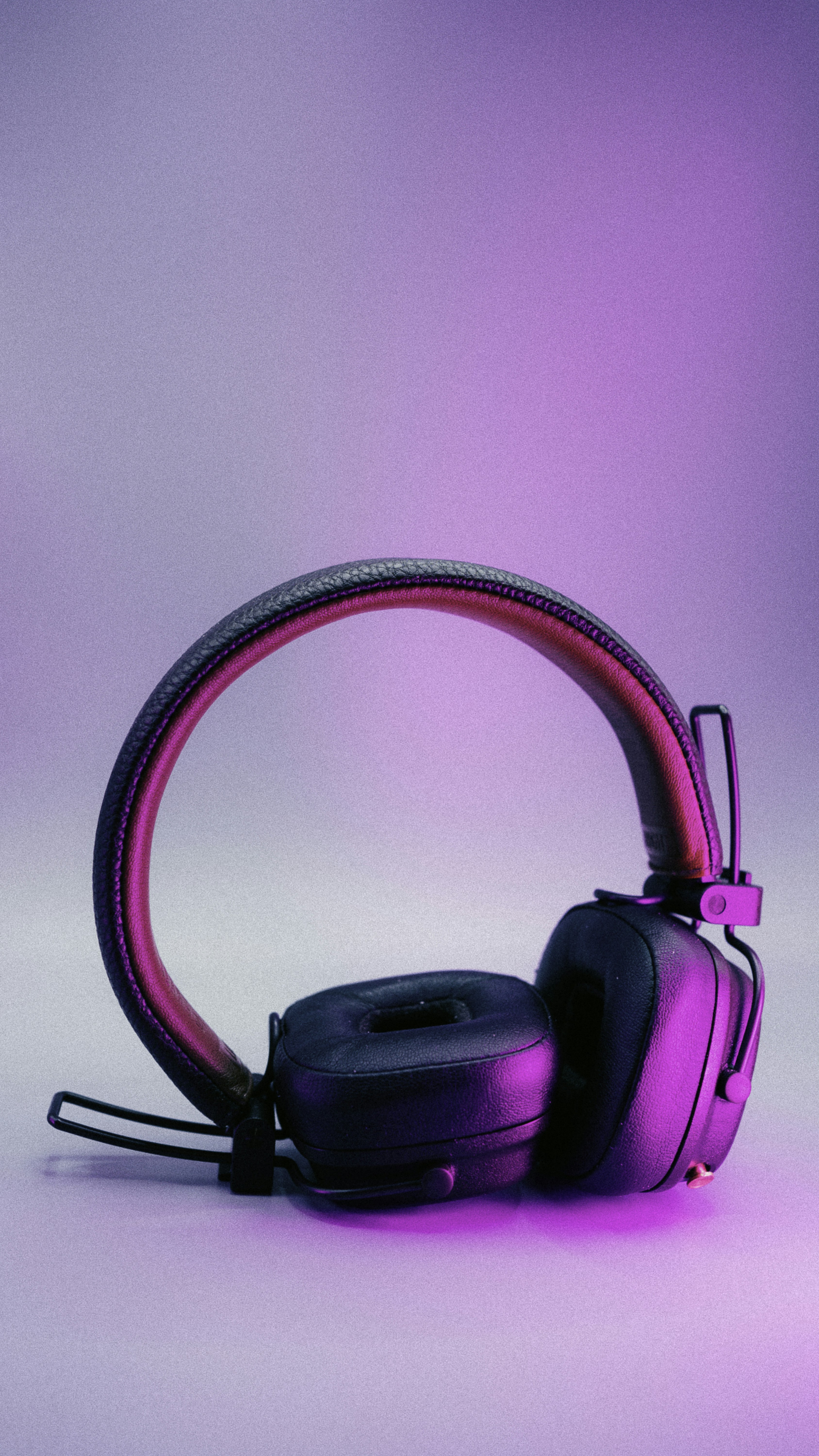 Neon Reverie: A Quiet Portrait of Headphones Under Purple-Pink Light
