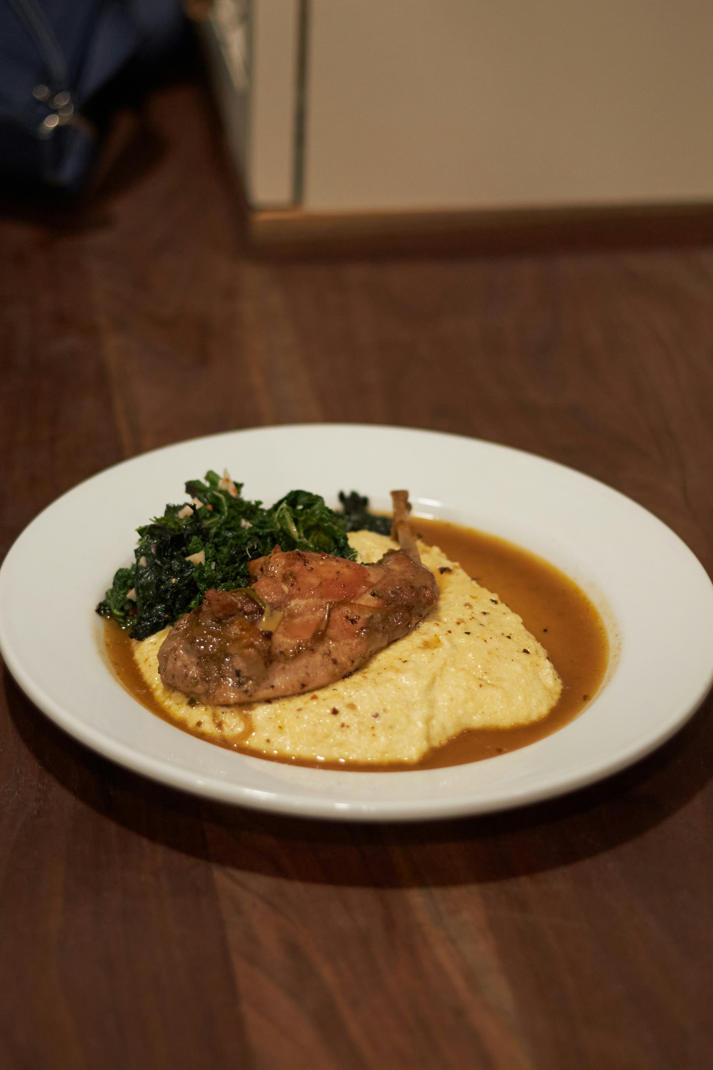 Lamb Chop on Creamy Polenta with Kale Greens in Rich Jus