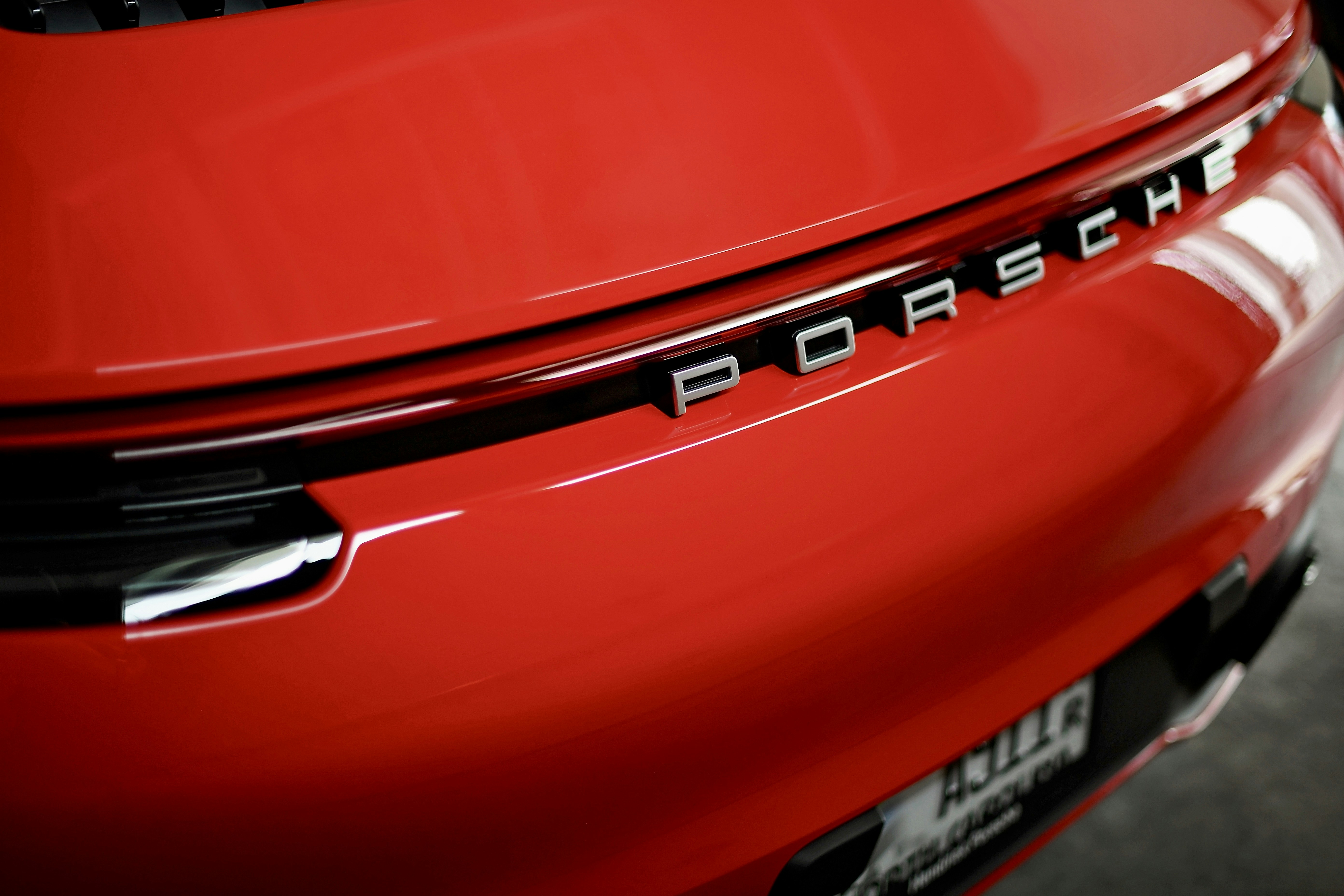 A red porsche parked in a parking lot photo – Free Charlotte Image on ...