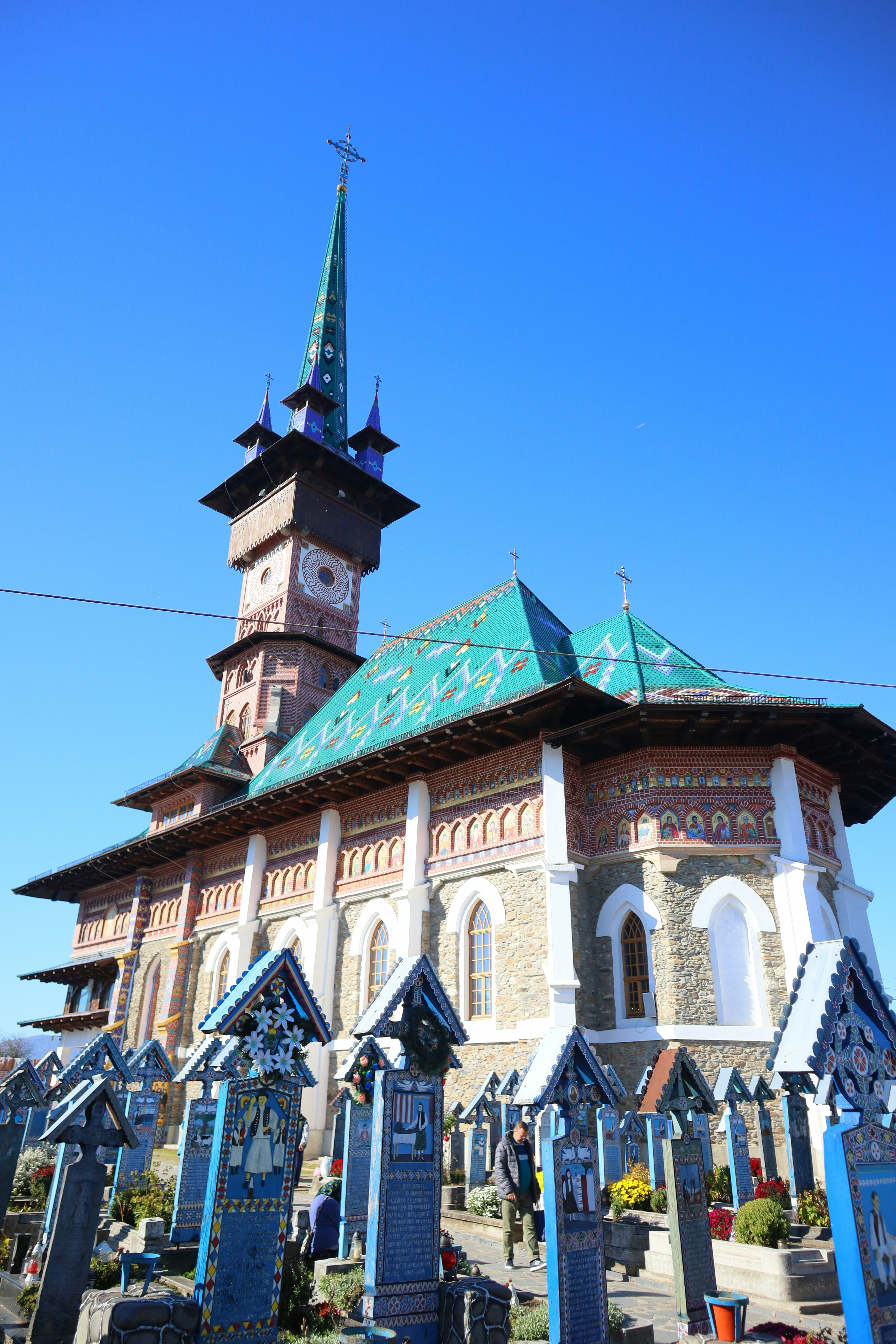 Ornate Clock Tower Rising Over a Painted Cemetery