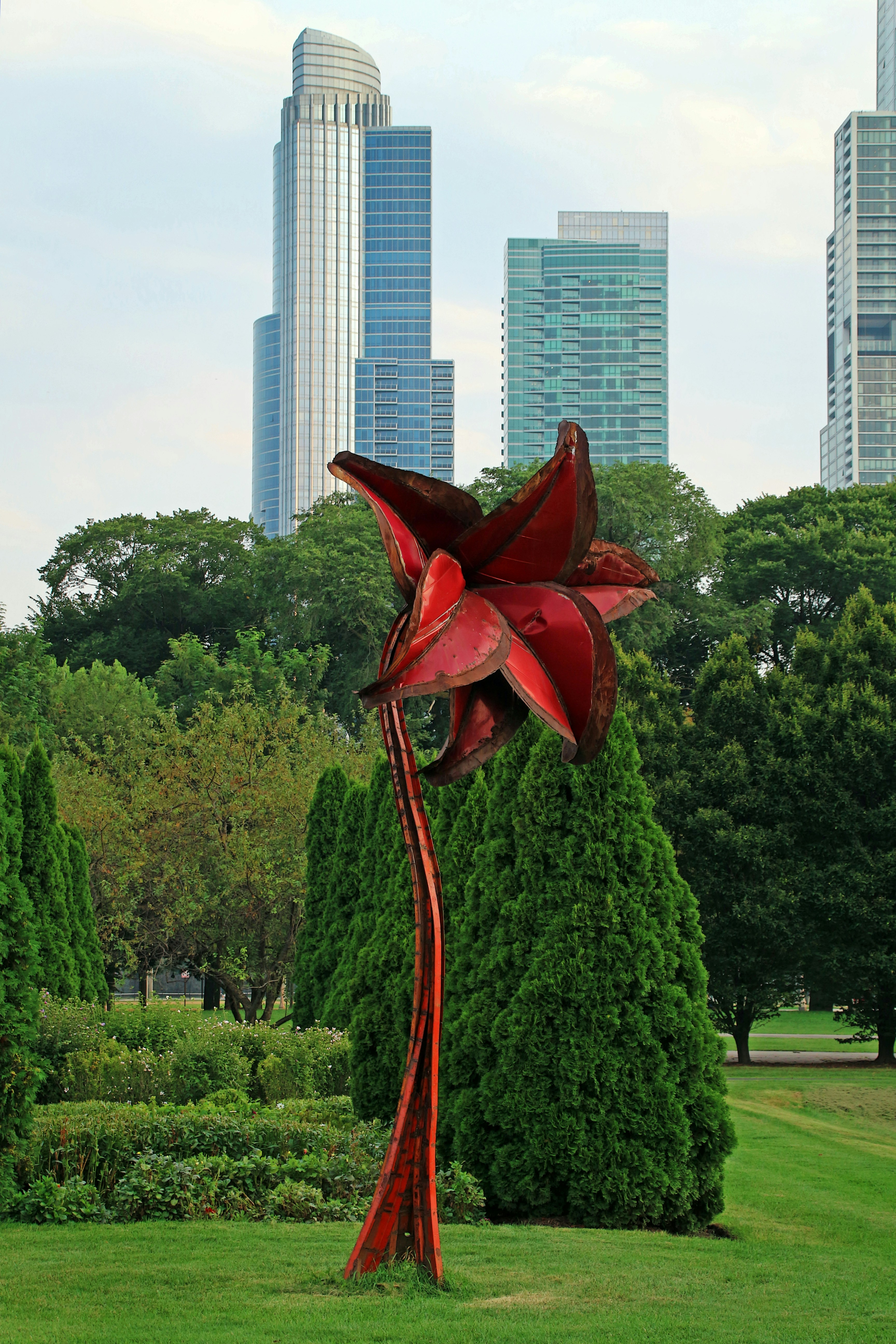 Crimson Iron Bloom Framed by a City Skyline