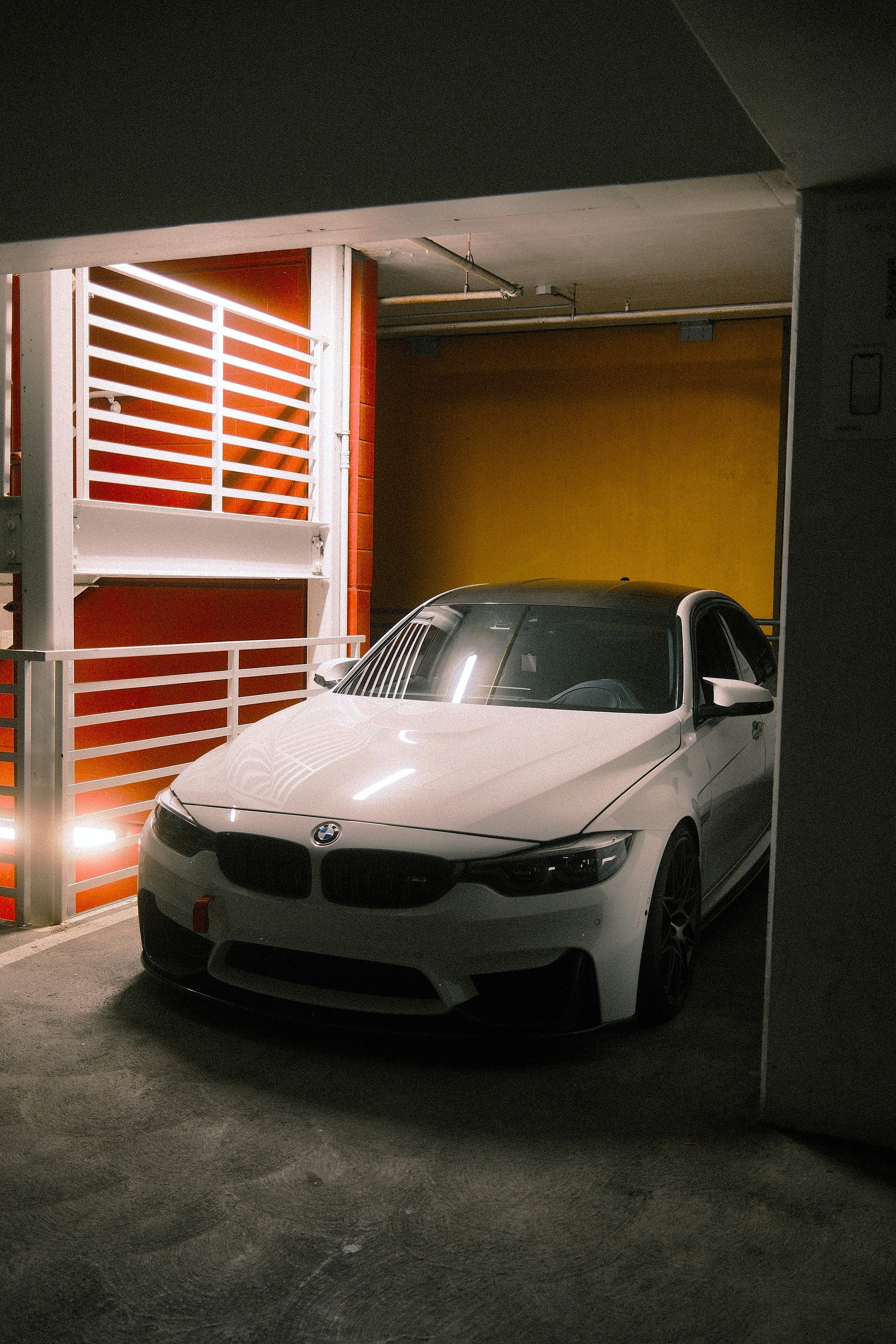 White BMW in a Neon-Accent Parking Garage