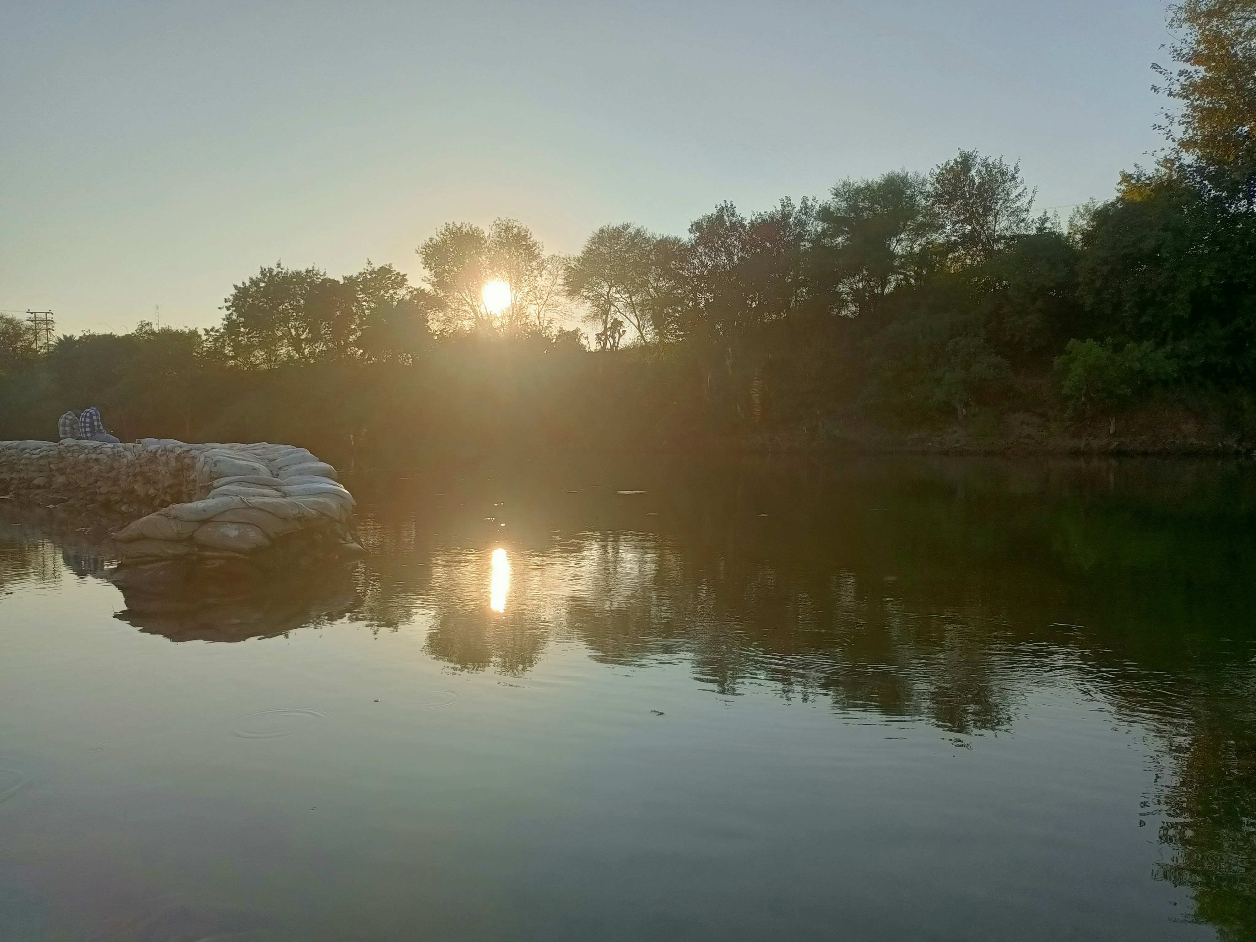 A body of water surrounded by trees and rocks photo – Free Rewa Image ...