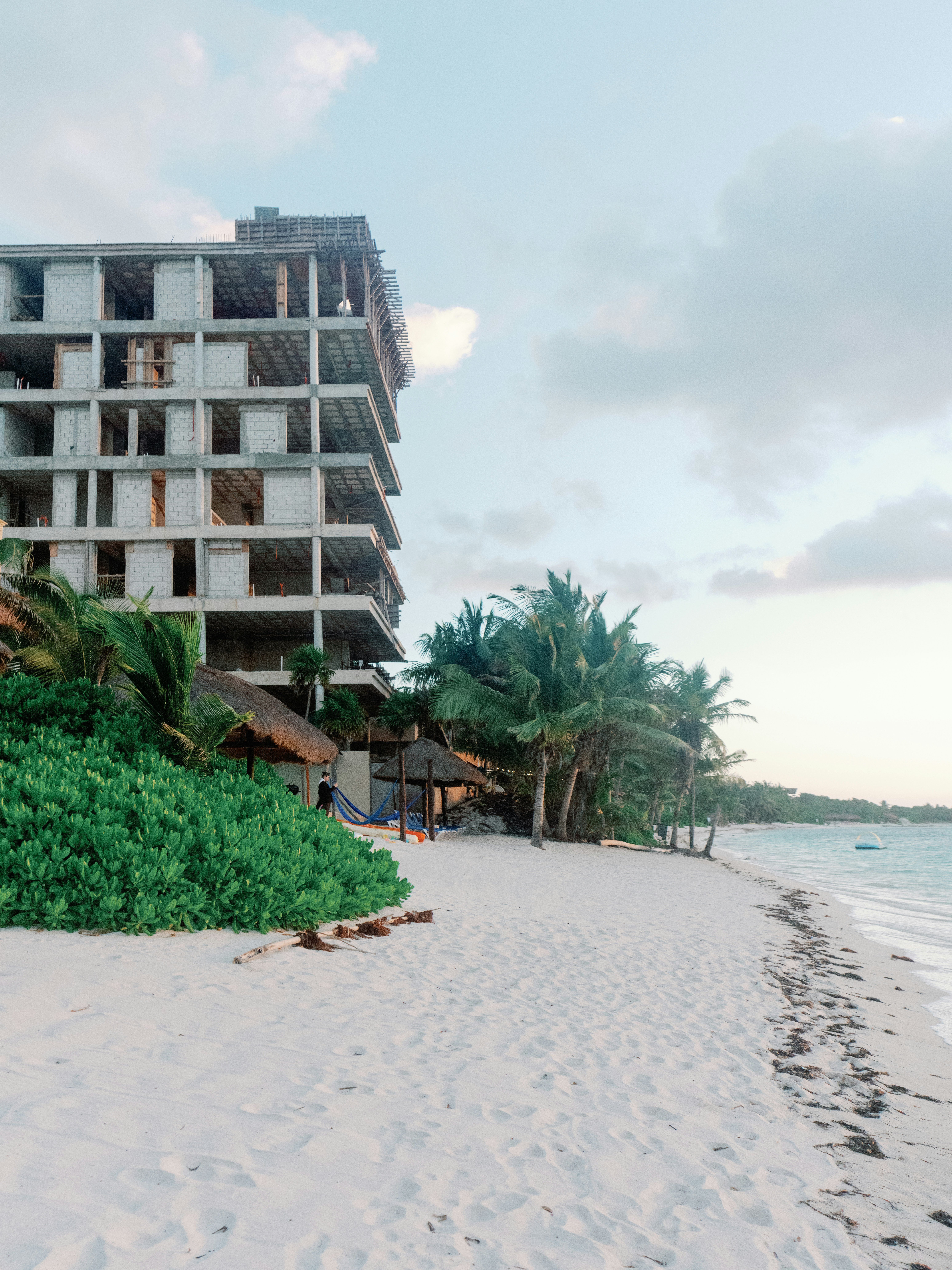 A building on a beach next to the ocean photo – Free Soliman bay Image ...