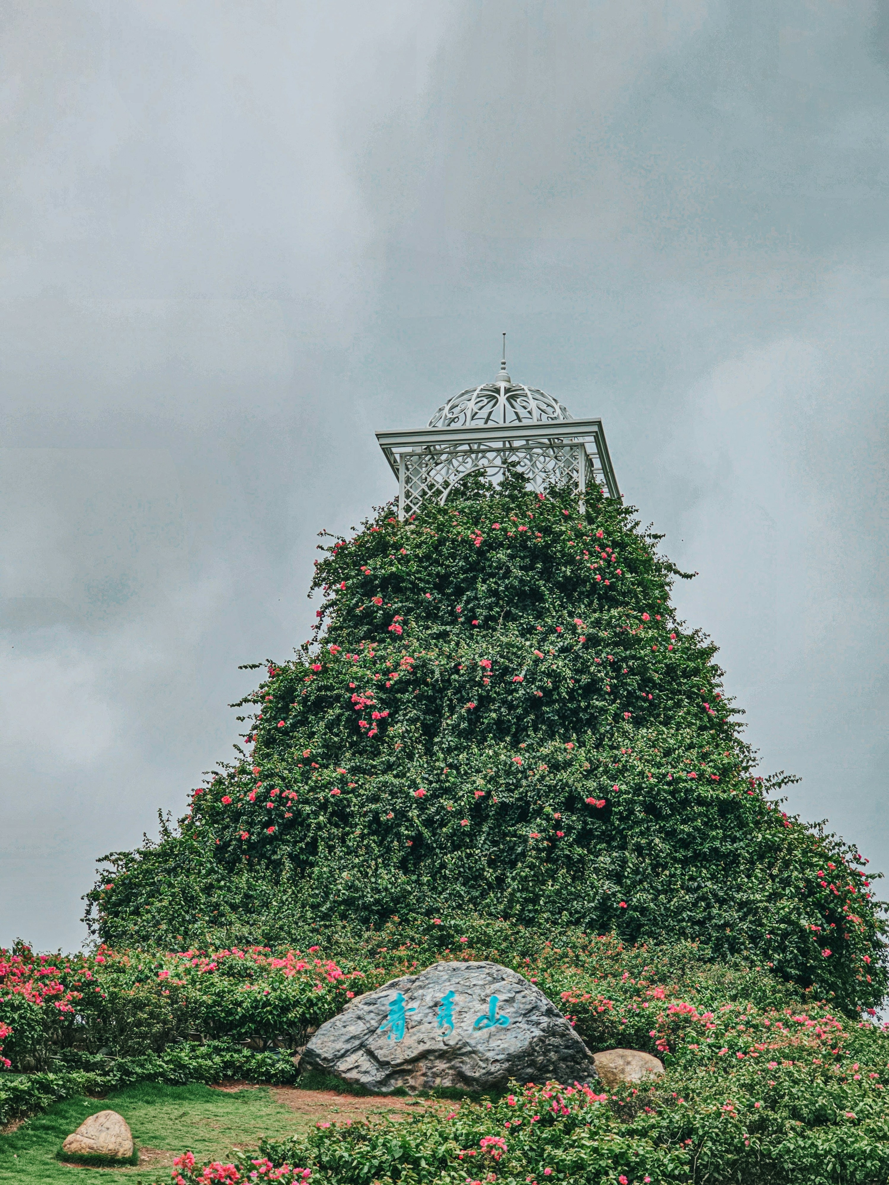 Ivy-Cloaked Turret Rising Above a Pink-Bloomed Garden