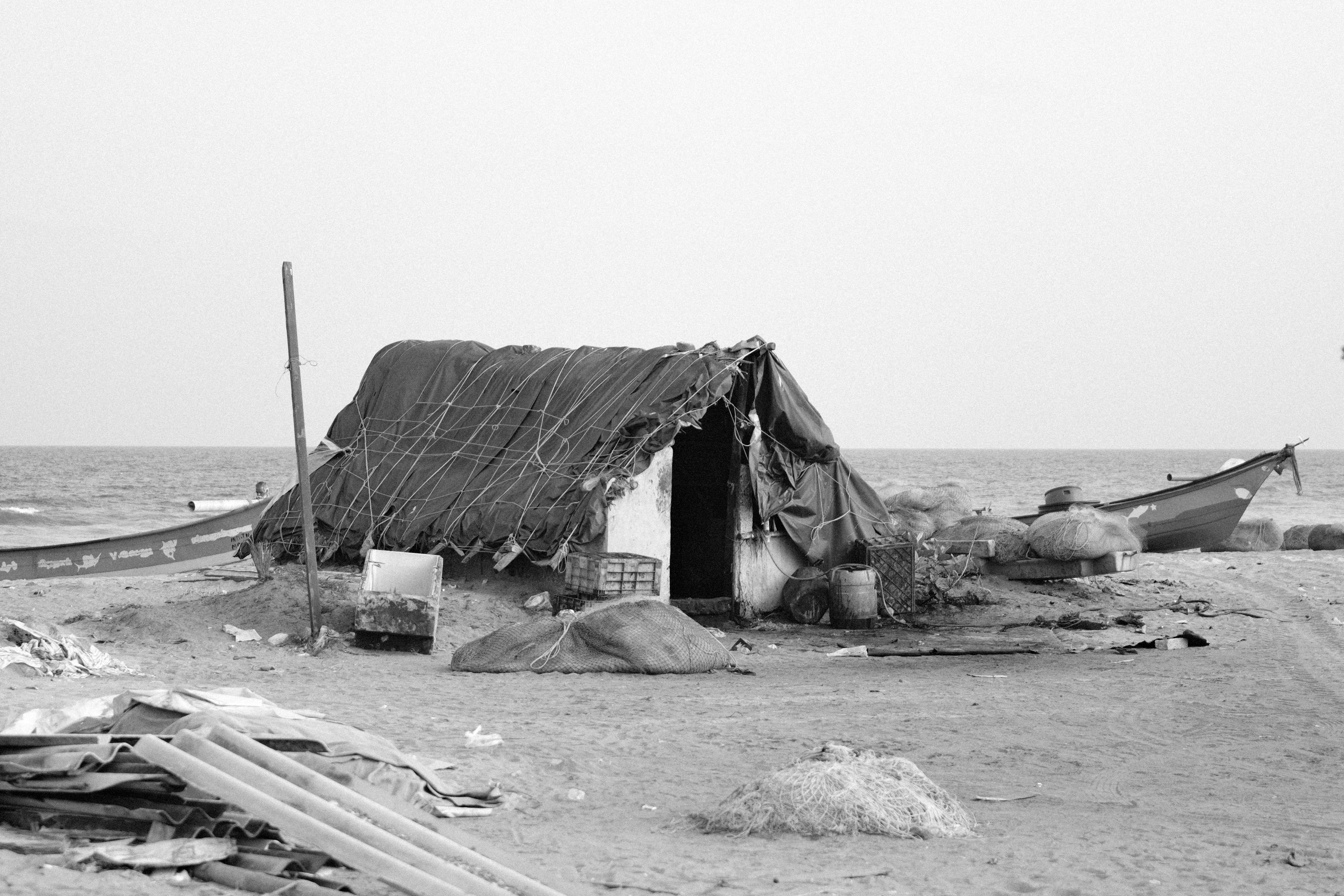 A black and white photo of a shack on the beach photo – Free Beach ...