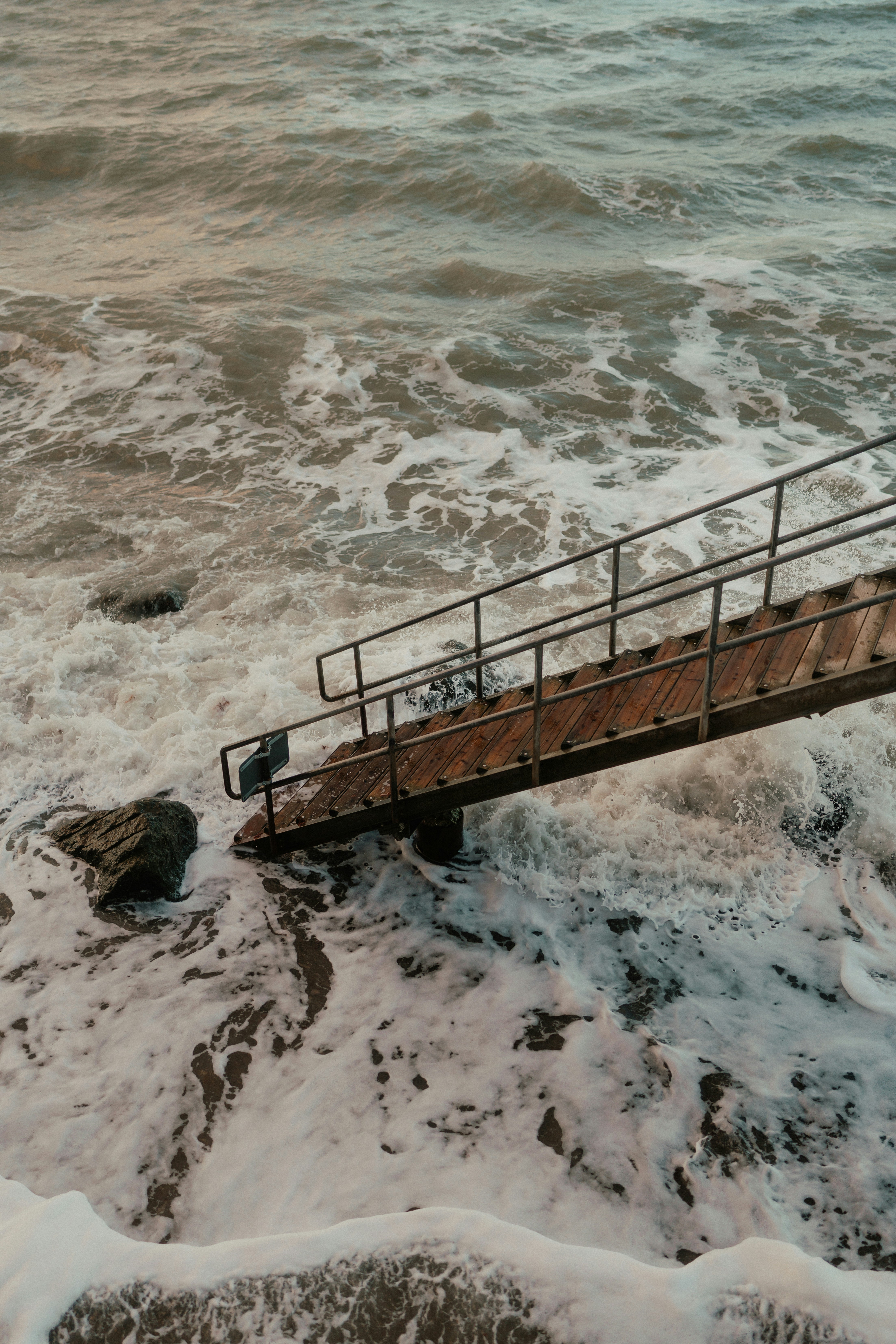 A wooden bridge over a body of water photo – Free Sea Image on Unsplash