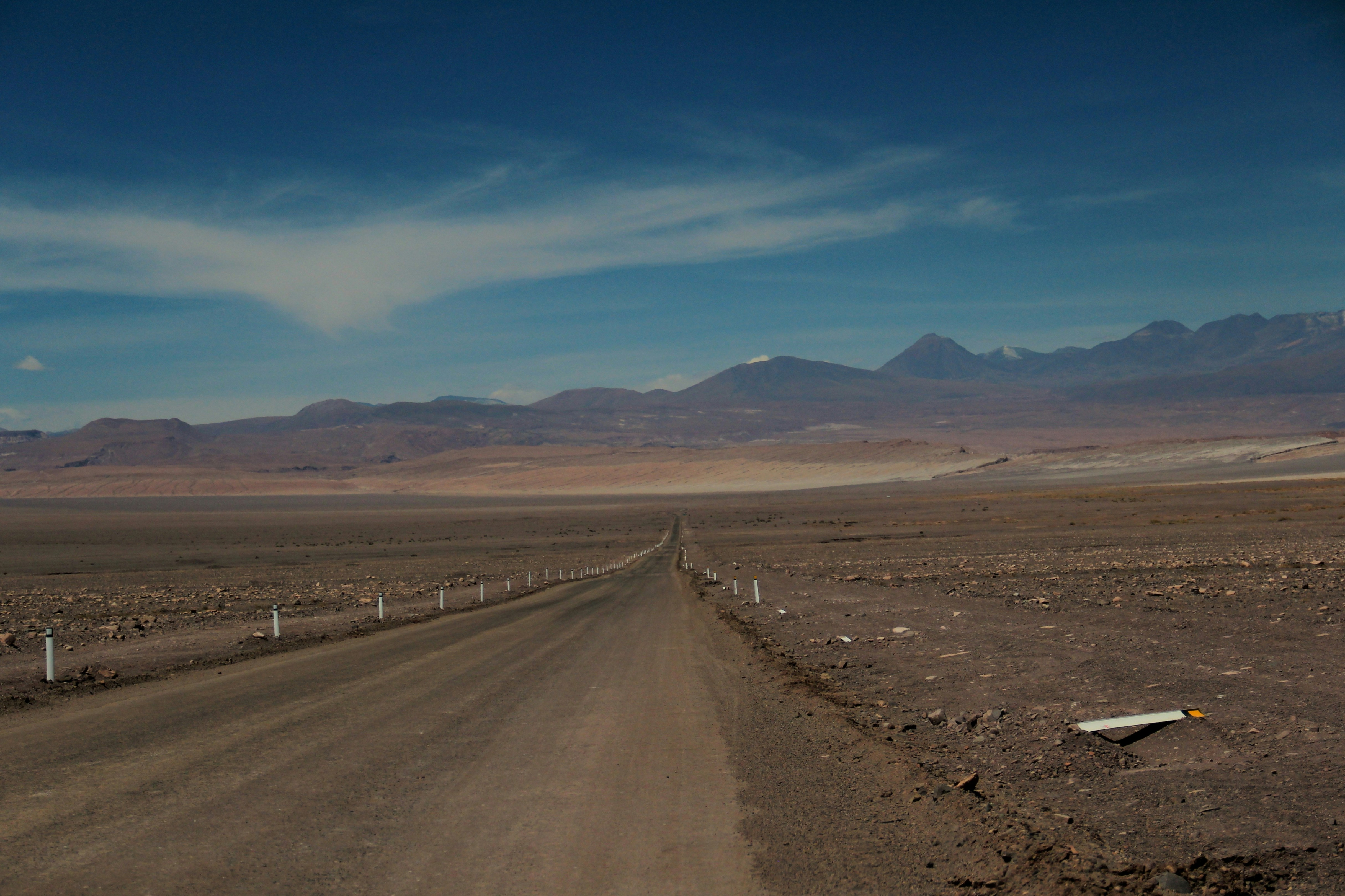 Dirt road with mountains in the background in the Atacama Desert in Chile.