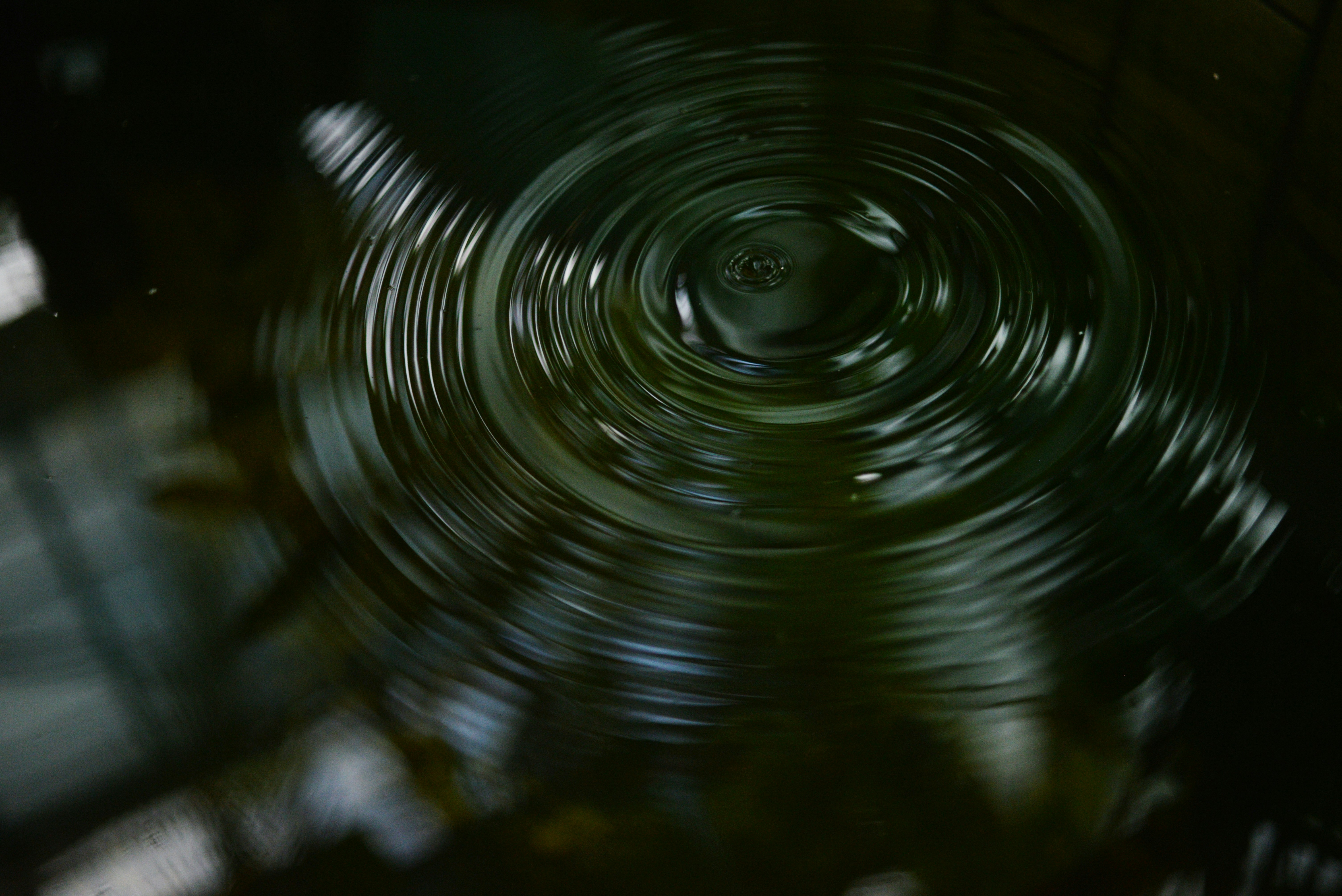 A close up of a water drop with a building in the background photo ...