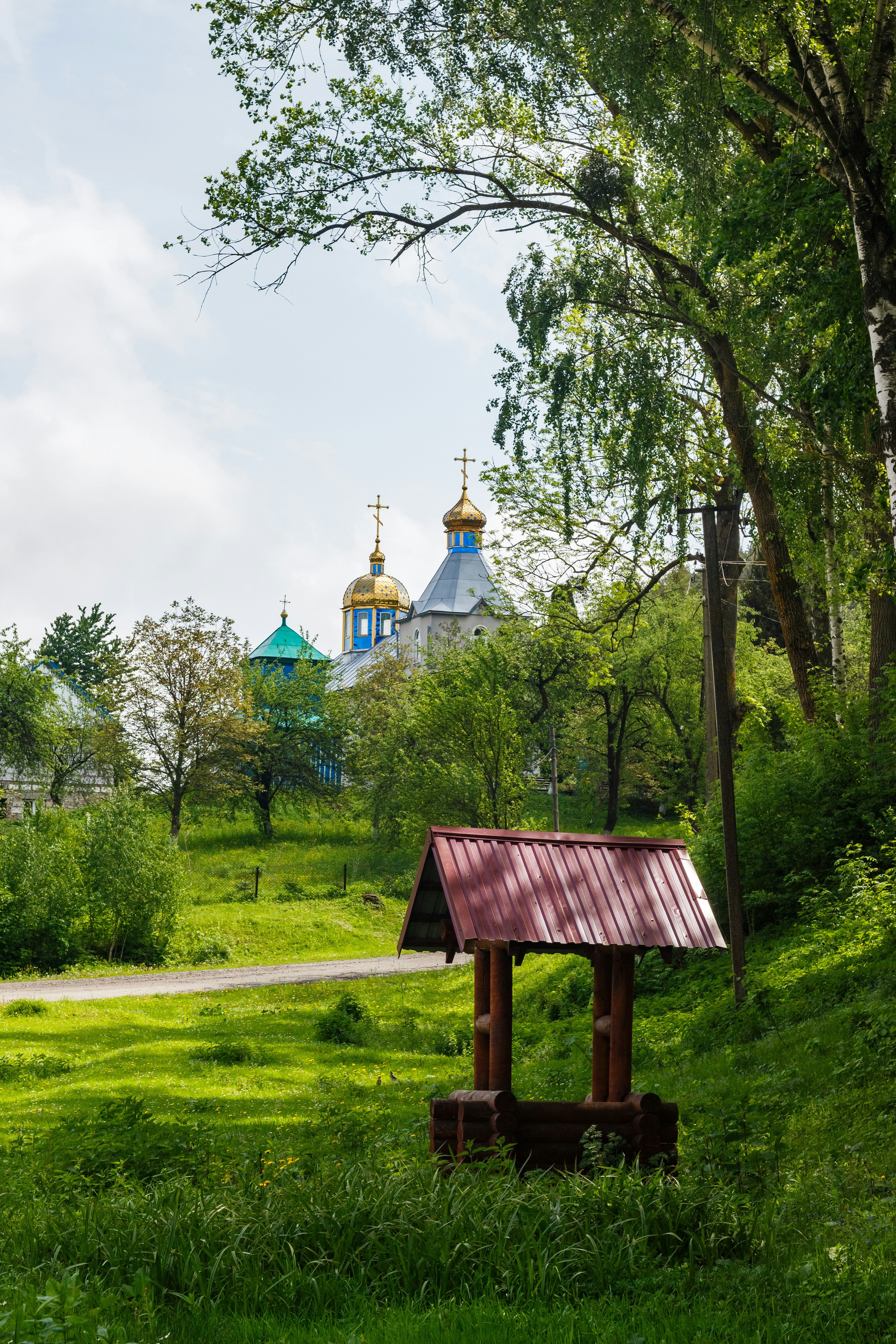 A Quiet Monastery Orchard Under a Sky of Green and Gold