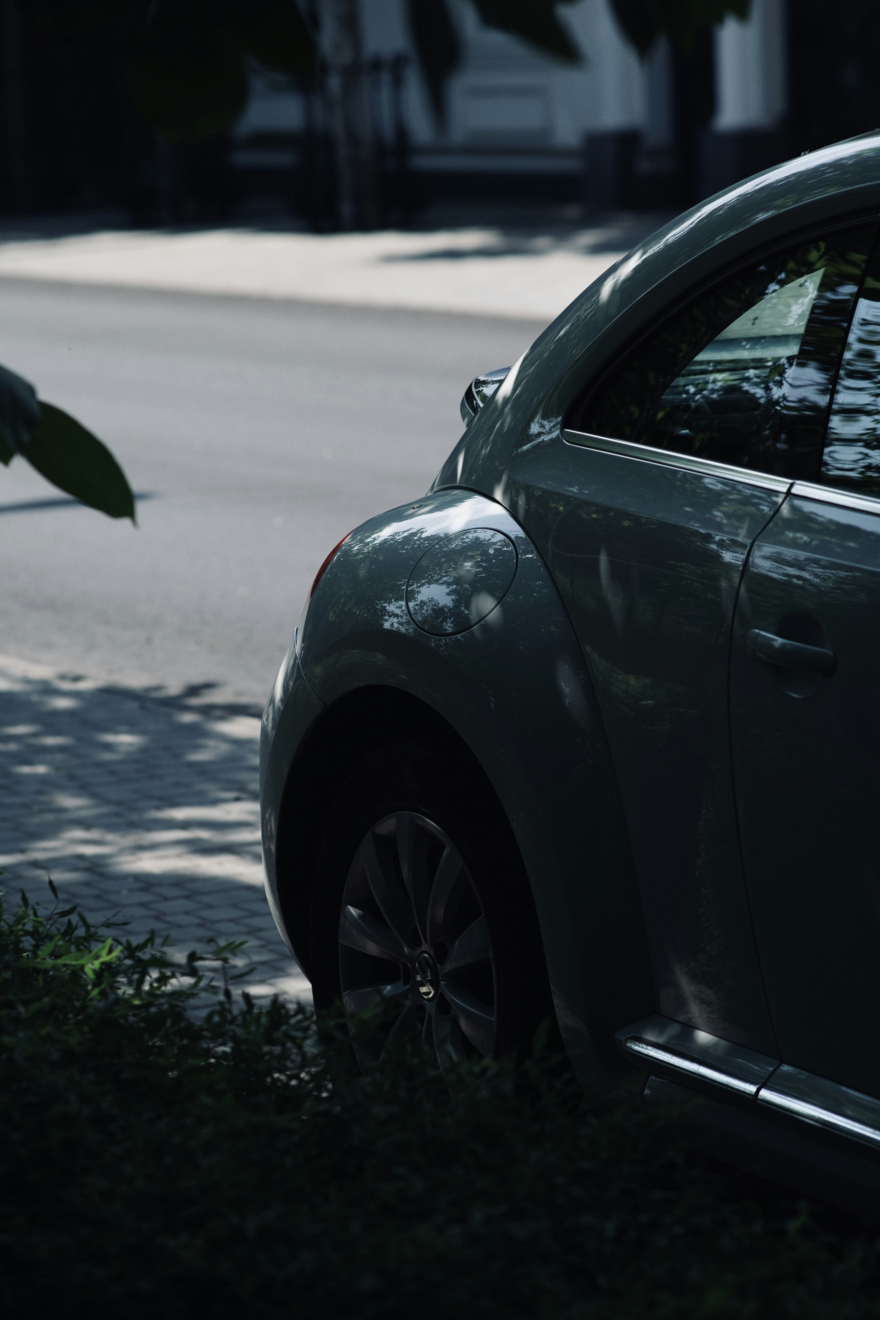 Curved Quiet: A Parked Green Car in Soft Street Light
