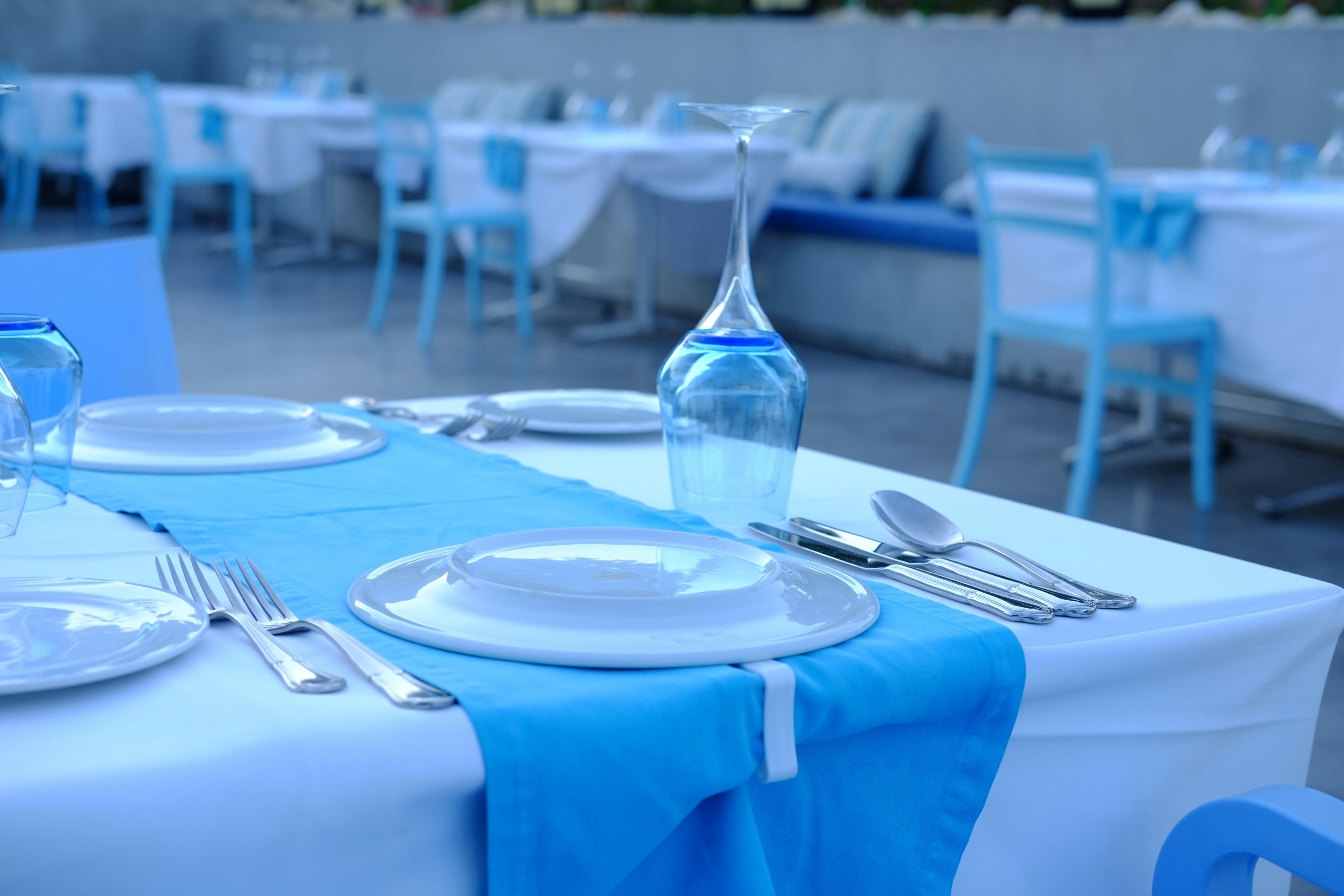 A table set with plates and silverware and a bottle of water