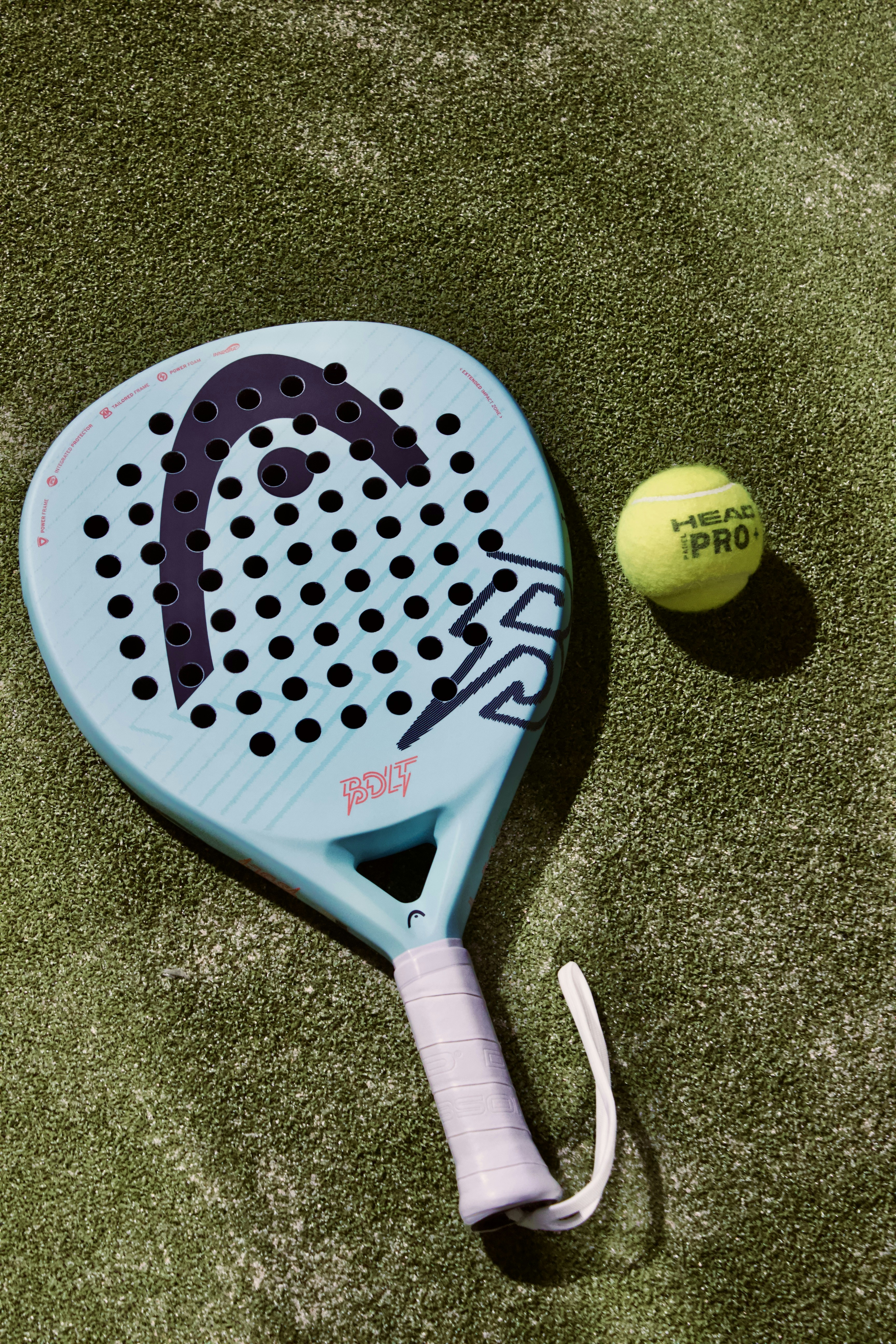 Aqua Padle Paddle and Neon Ball on a Textured Court