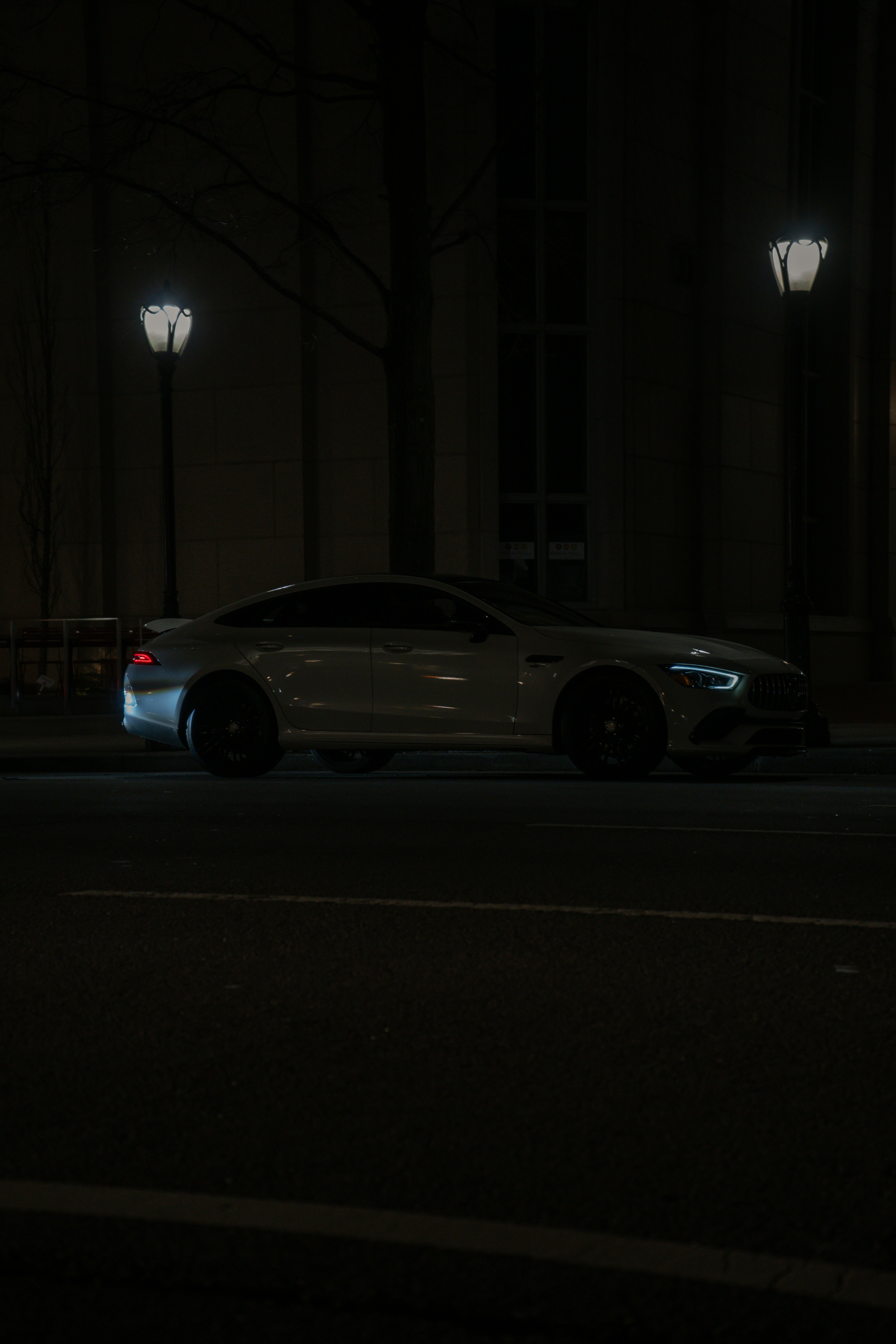 Moonlit Silver Sedan Under Twin Streetlamps