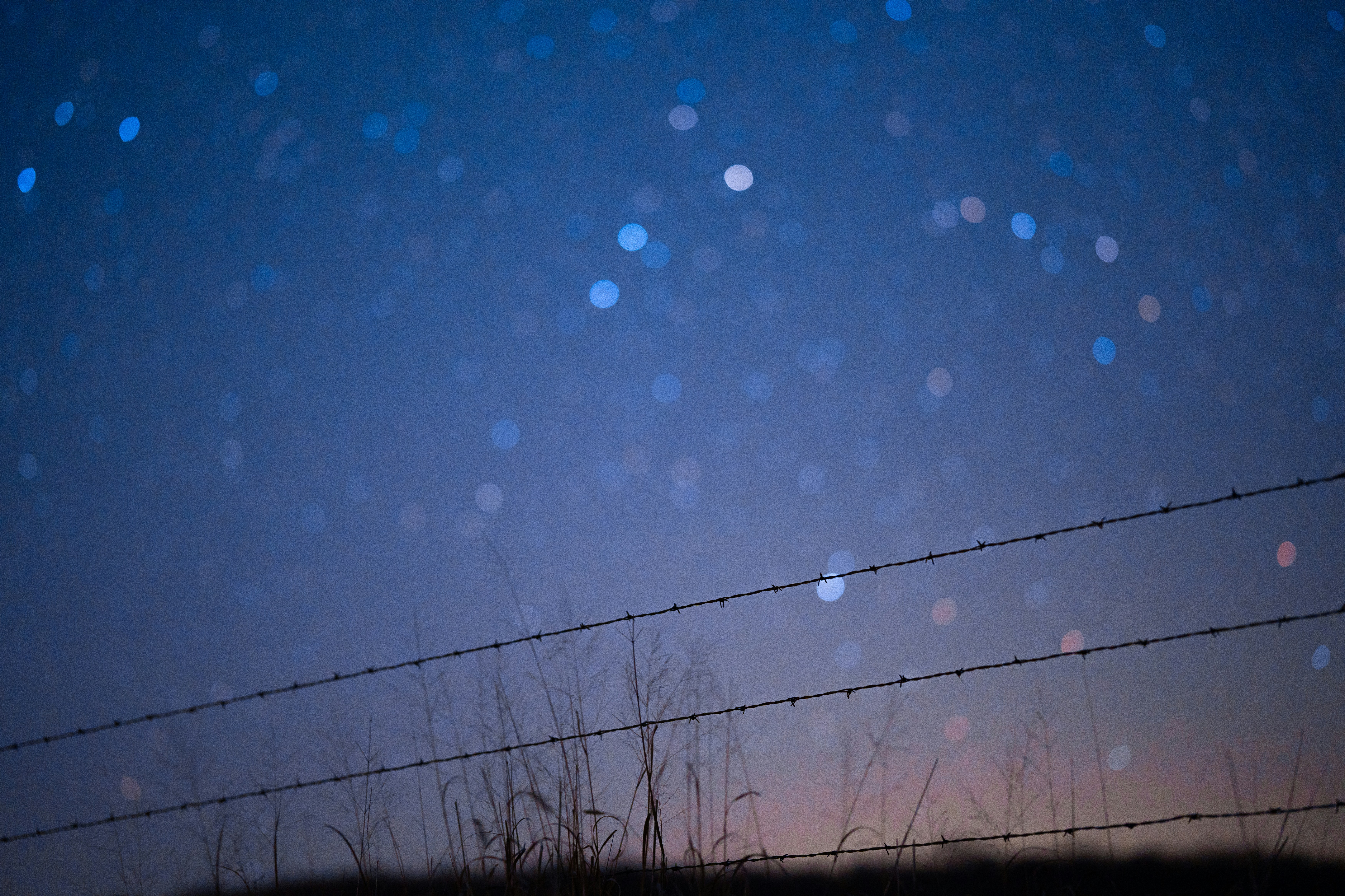 A fence with a barbed wire at night photo – Free Oklahoma Image on Unsplash