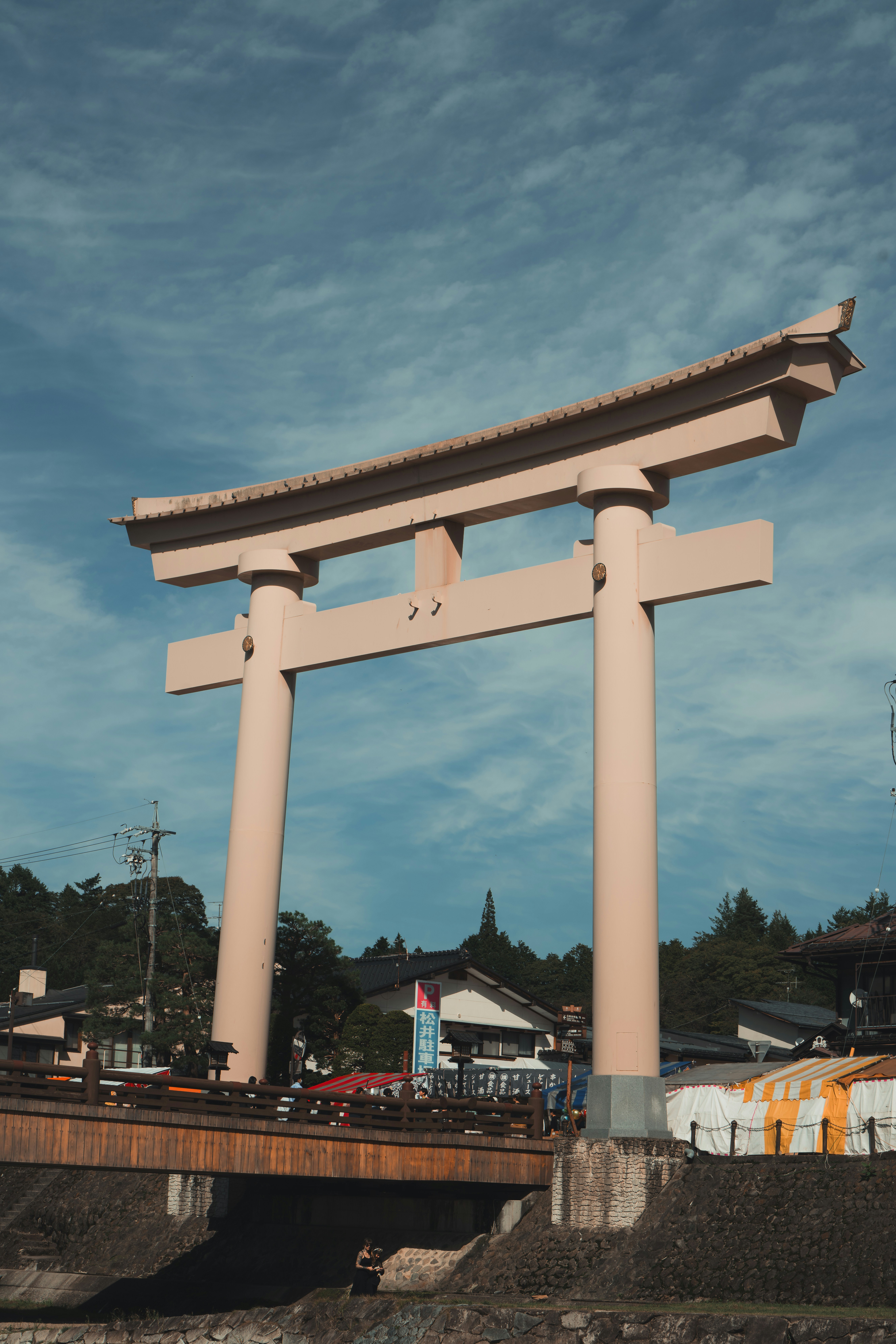 Sunlit Torii Over a Quiet Riverside Market