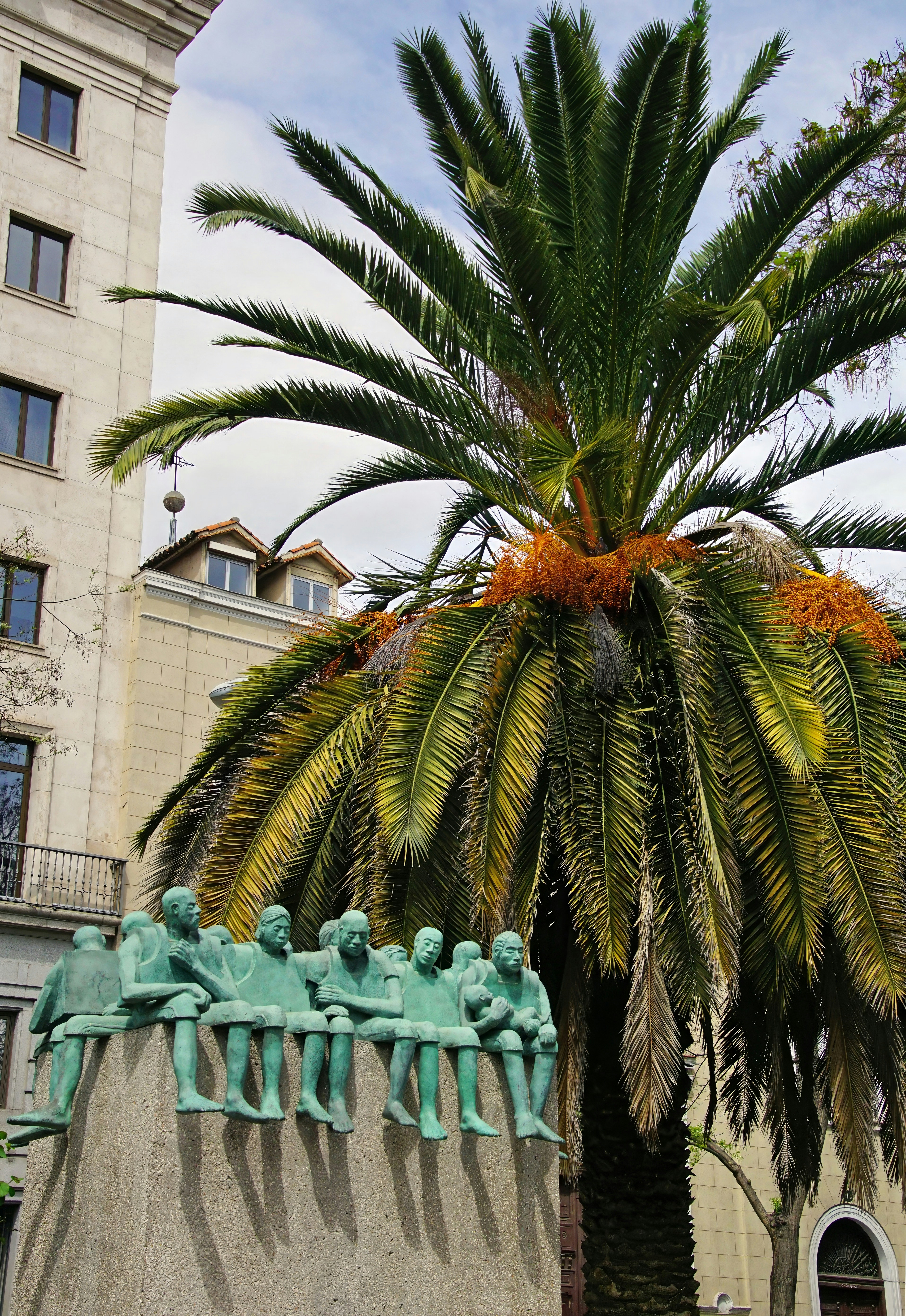 A sculpture and a palm three in Madrid, Spain.