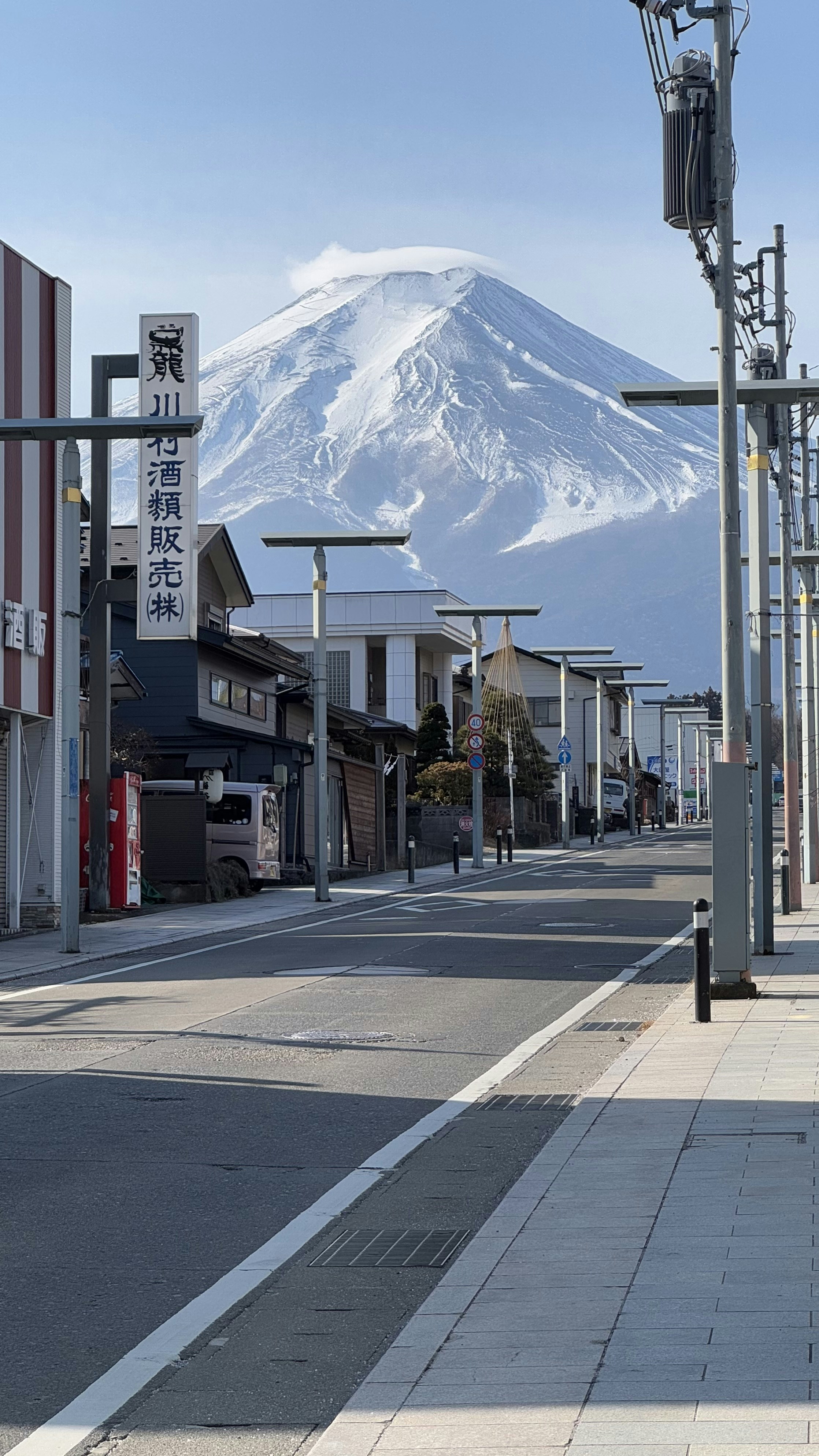 Toward the Snow-Capped Fuji: A Quiet Street Framed by a Majestic Peak