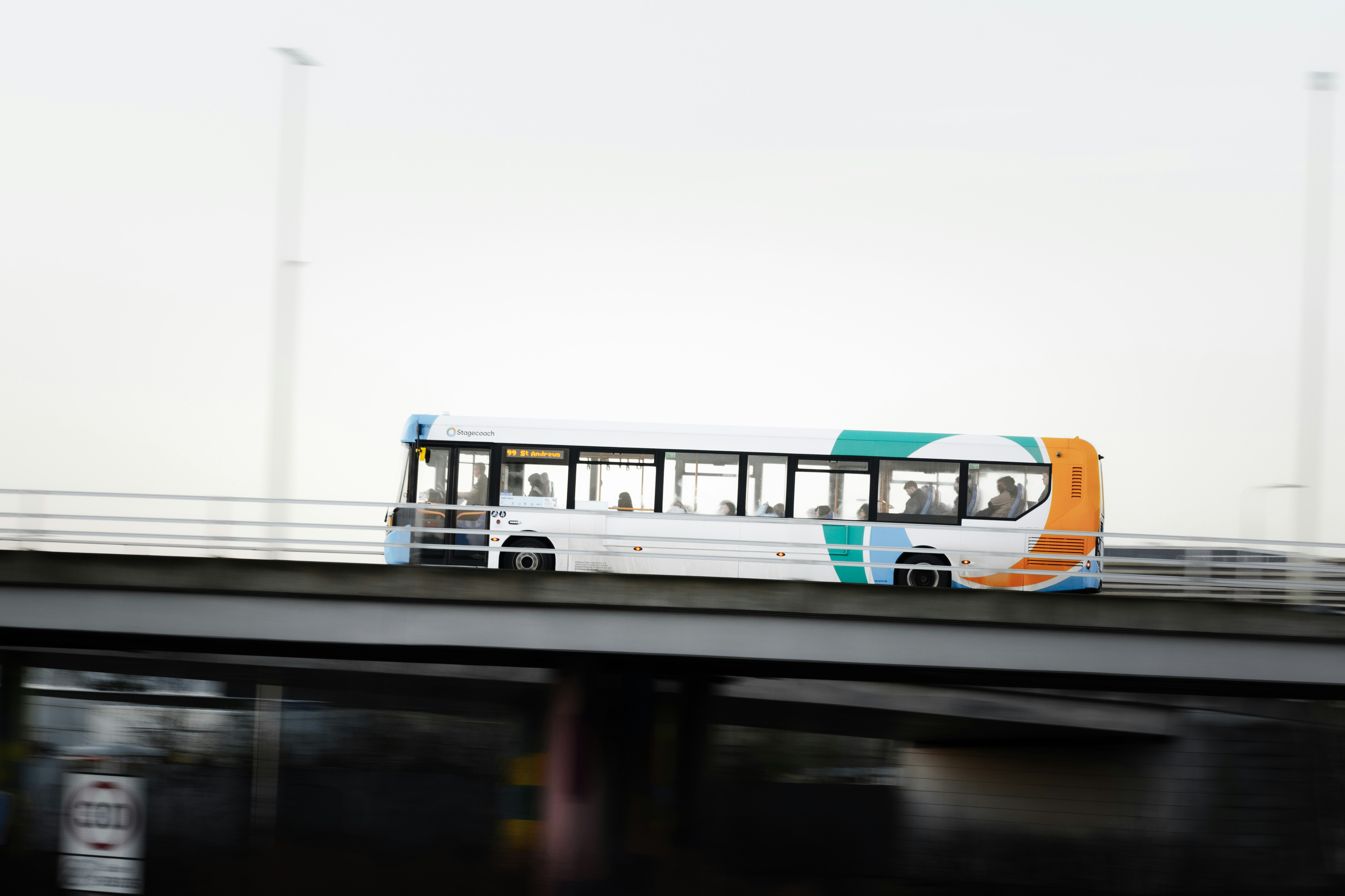 A bus driving on a bridge with a sky background photo – Free Wallpaper ...
