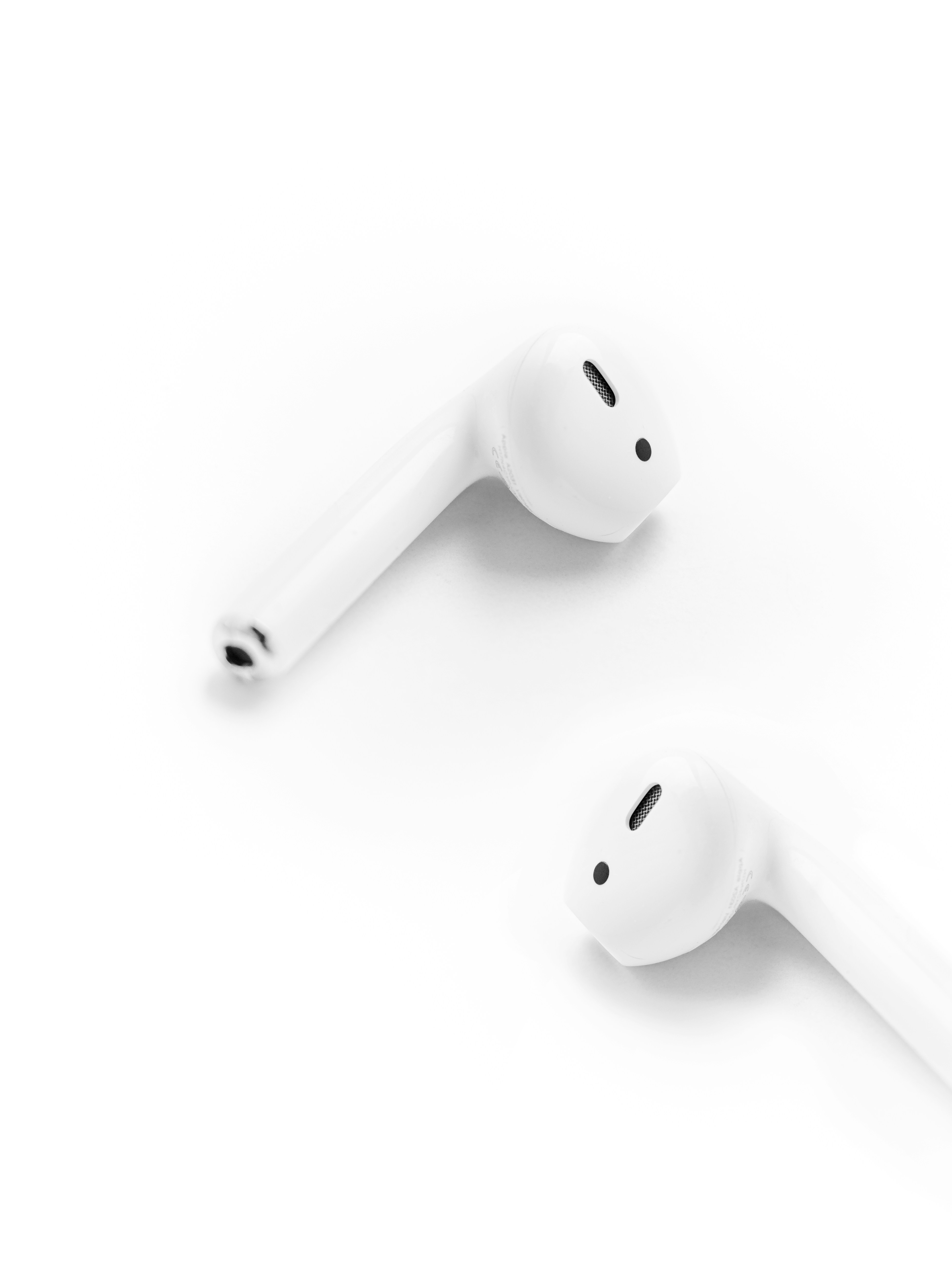 A pair of ear buds sitting next to each other photo – Free Technology ...