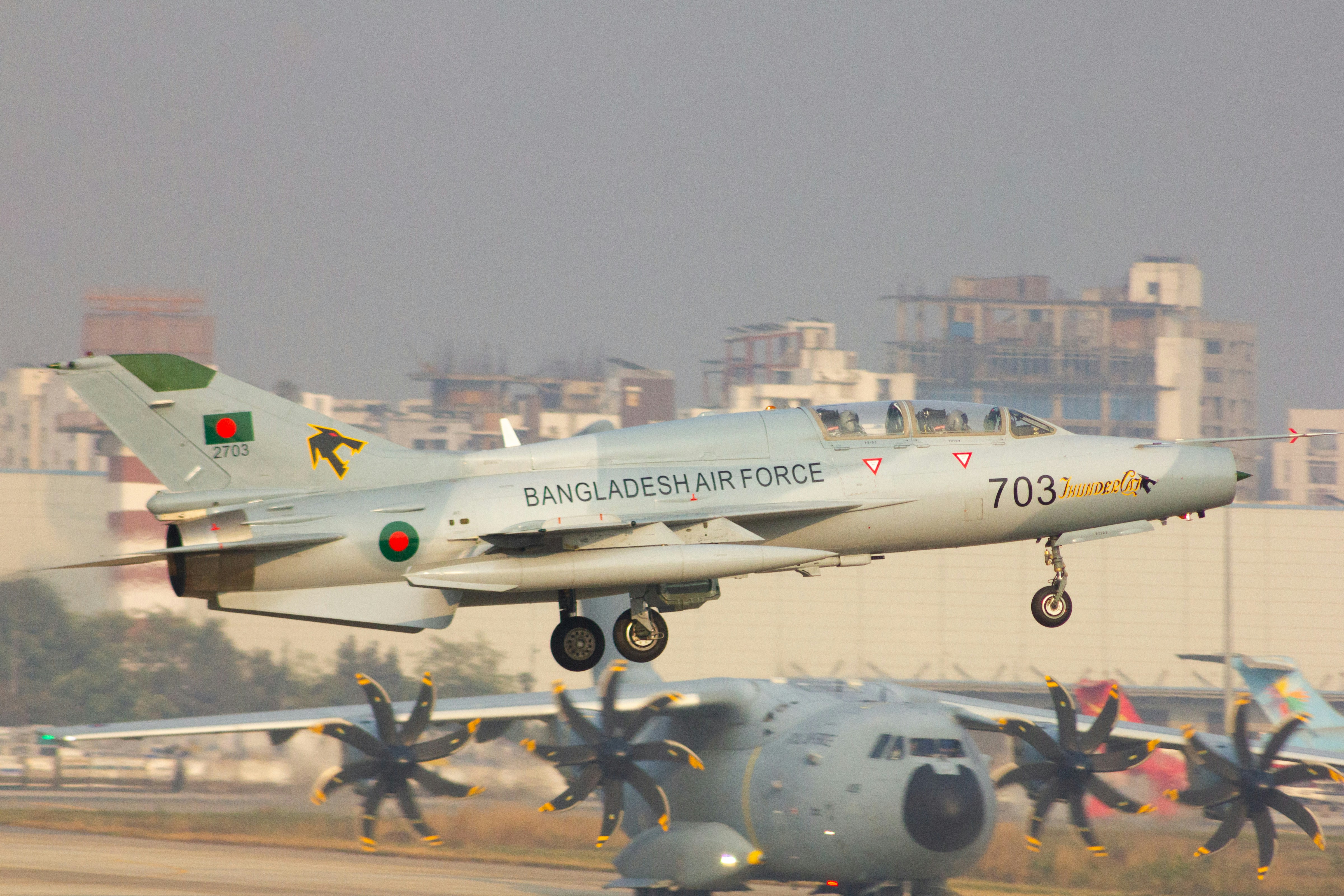 Glide Path Over Runway: Bangladesh Air Force Fighter in Final Approach with a Cargo Aircraft in the Background
