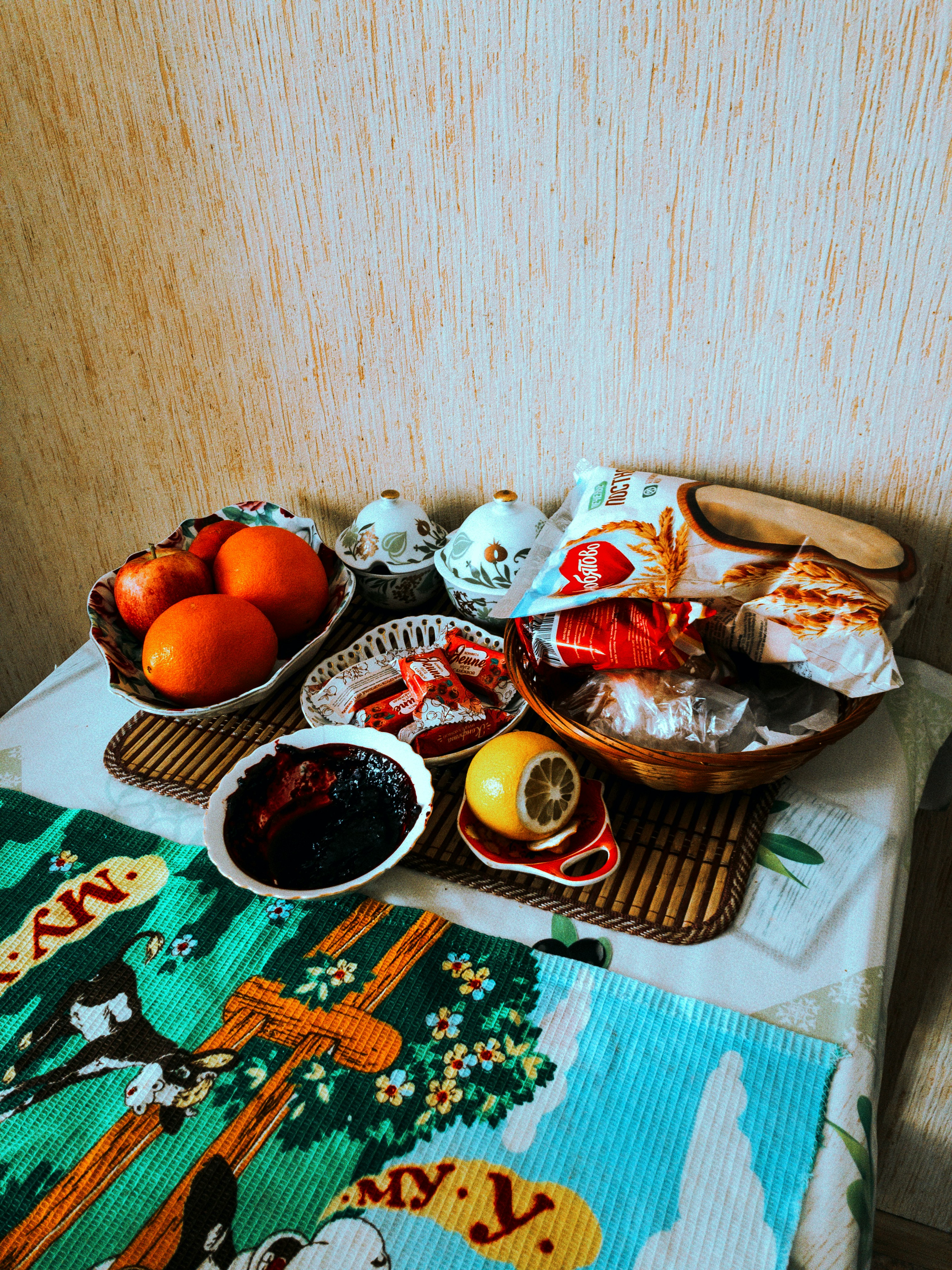 A table topped with plates of food and bowls of fruit photo – Free ...