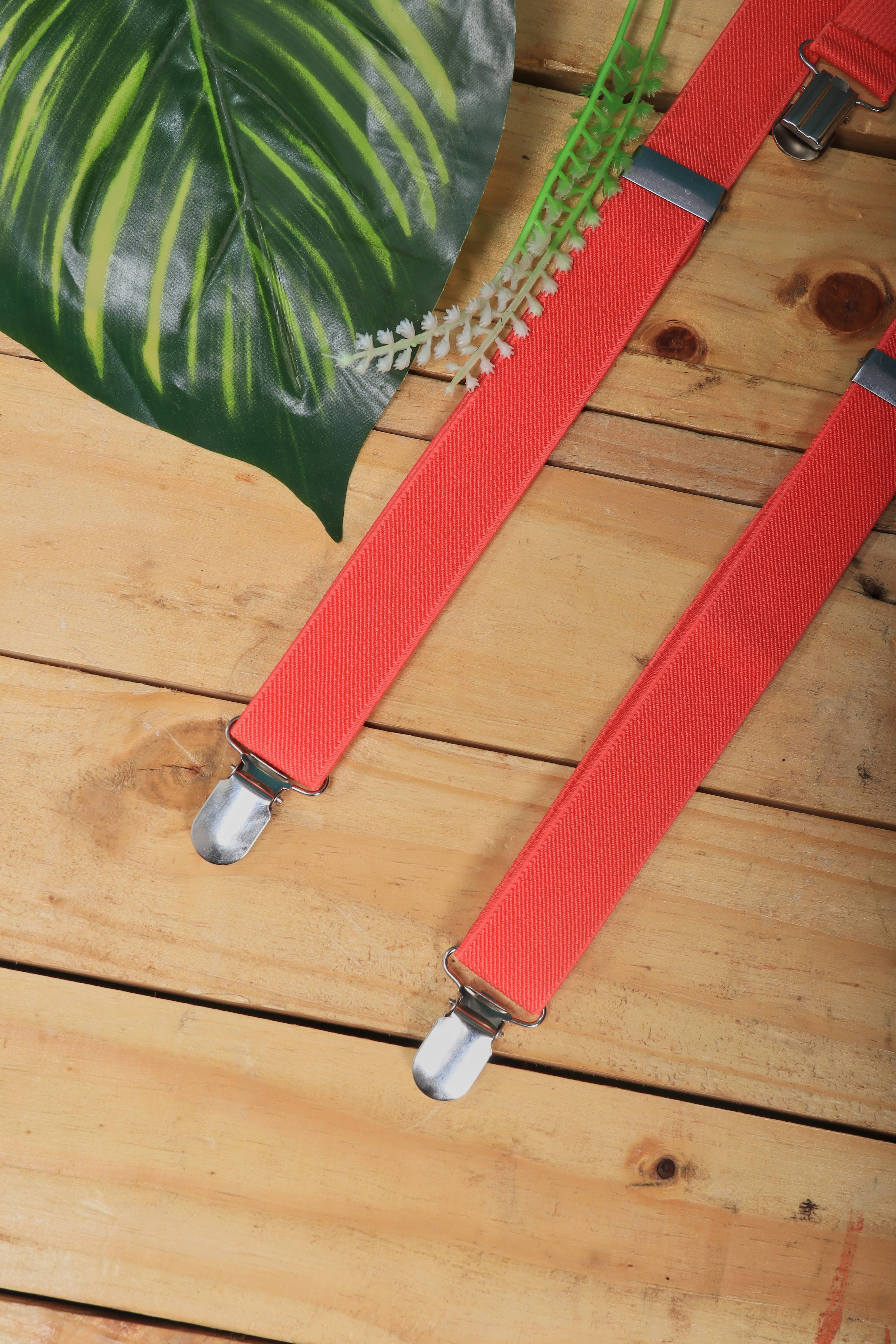 A pair of red suspenders sitting on top of a wooden floor photo – Free ...