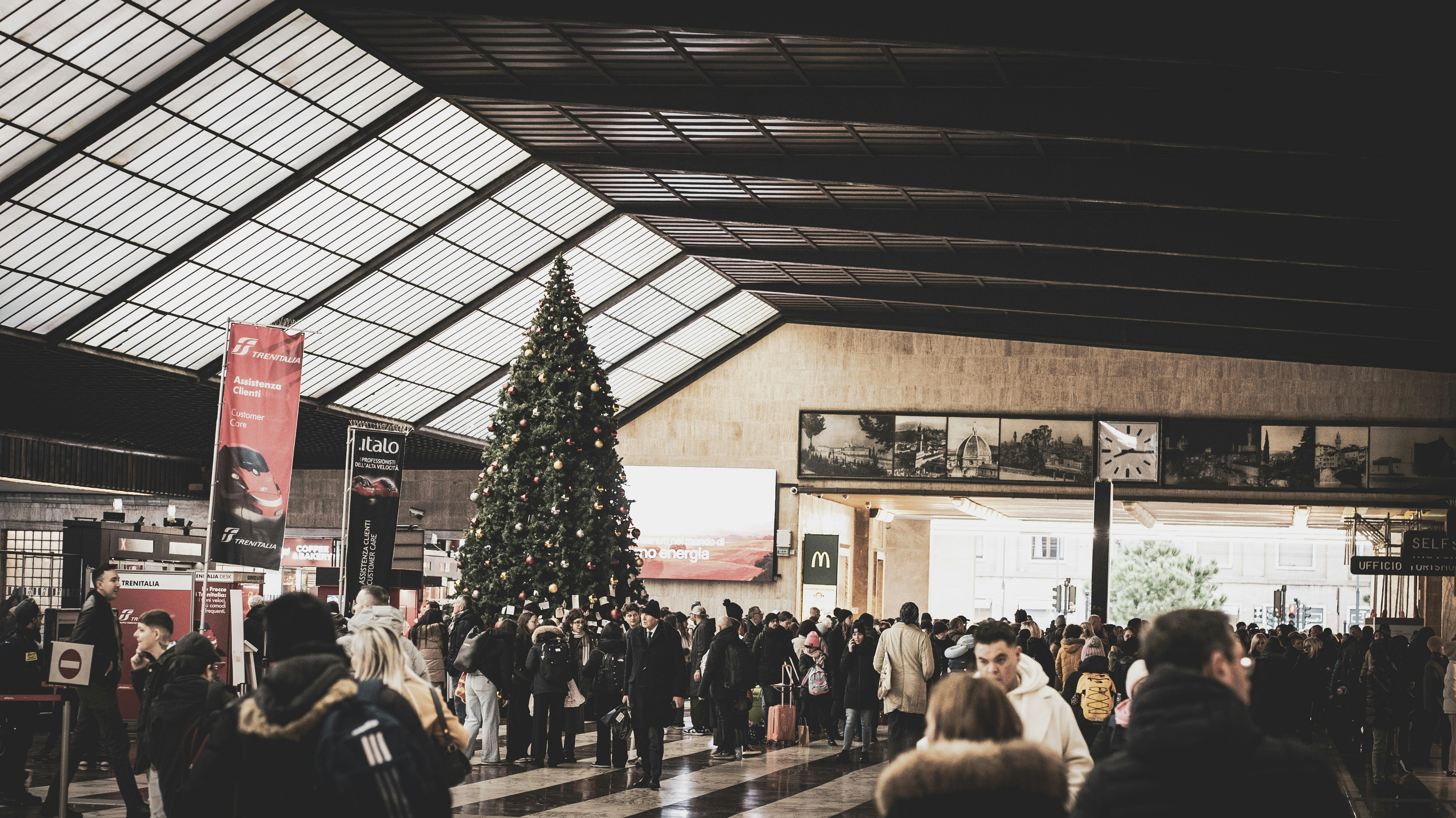 Crowded Terminal Gathers Around a Majestic Christmas Tree