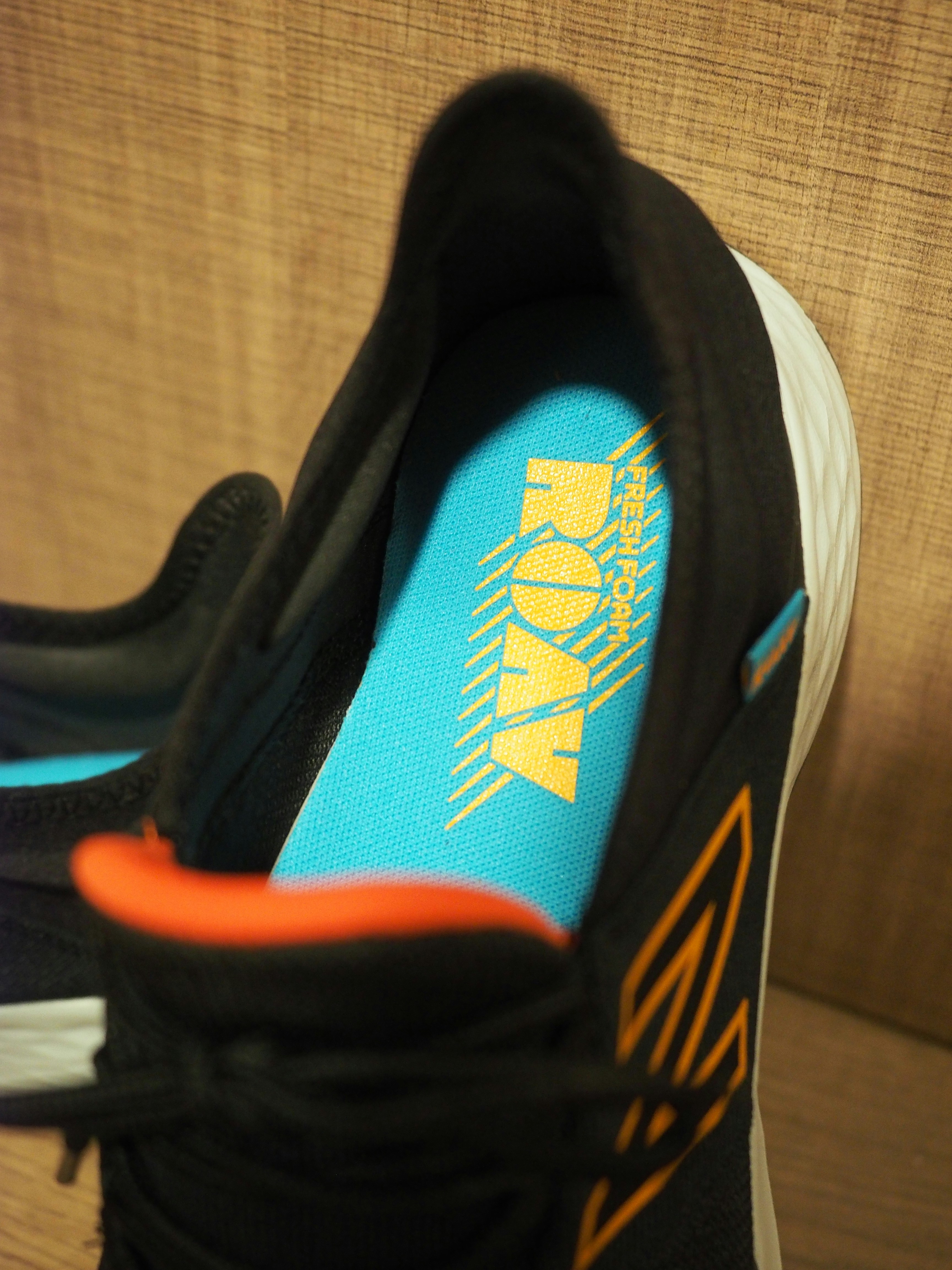 Electric Turquoise Insole Illuminates a Black Sneaker's Interior