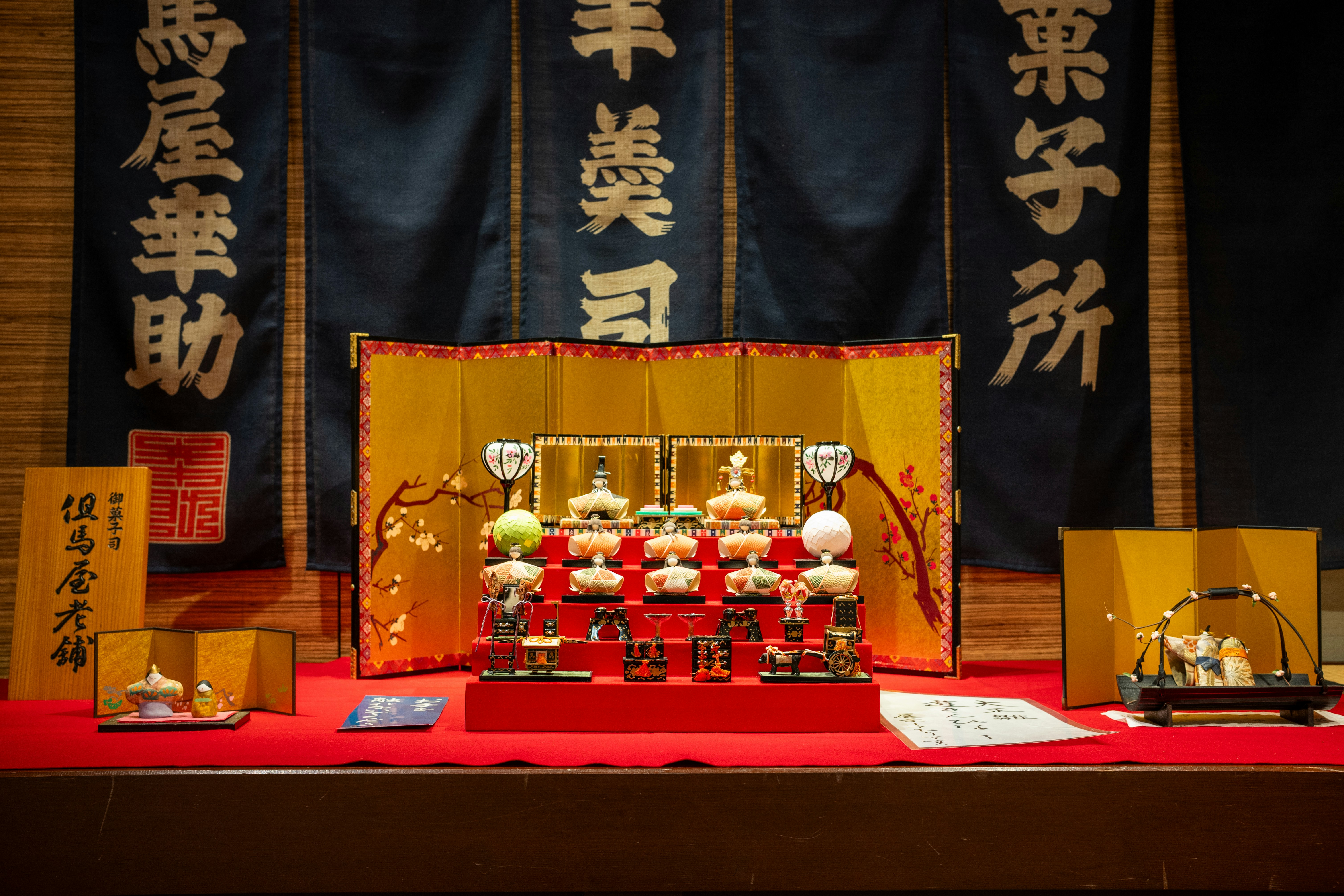 Hina Matsuri on a Crimson Stage: A Tiered Doll Display Under a Golden Screen
