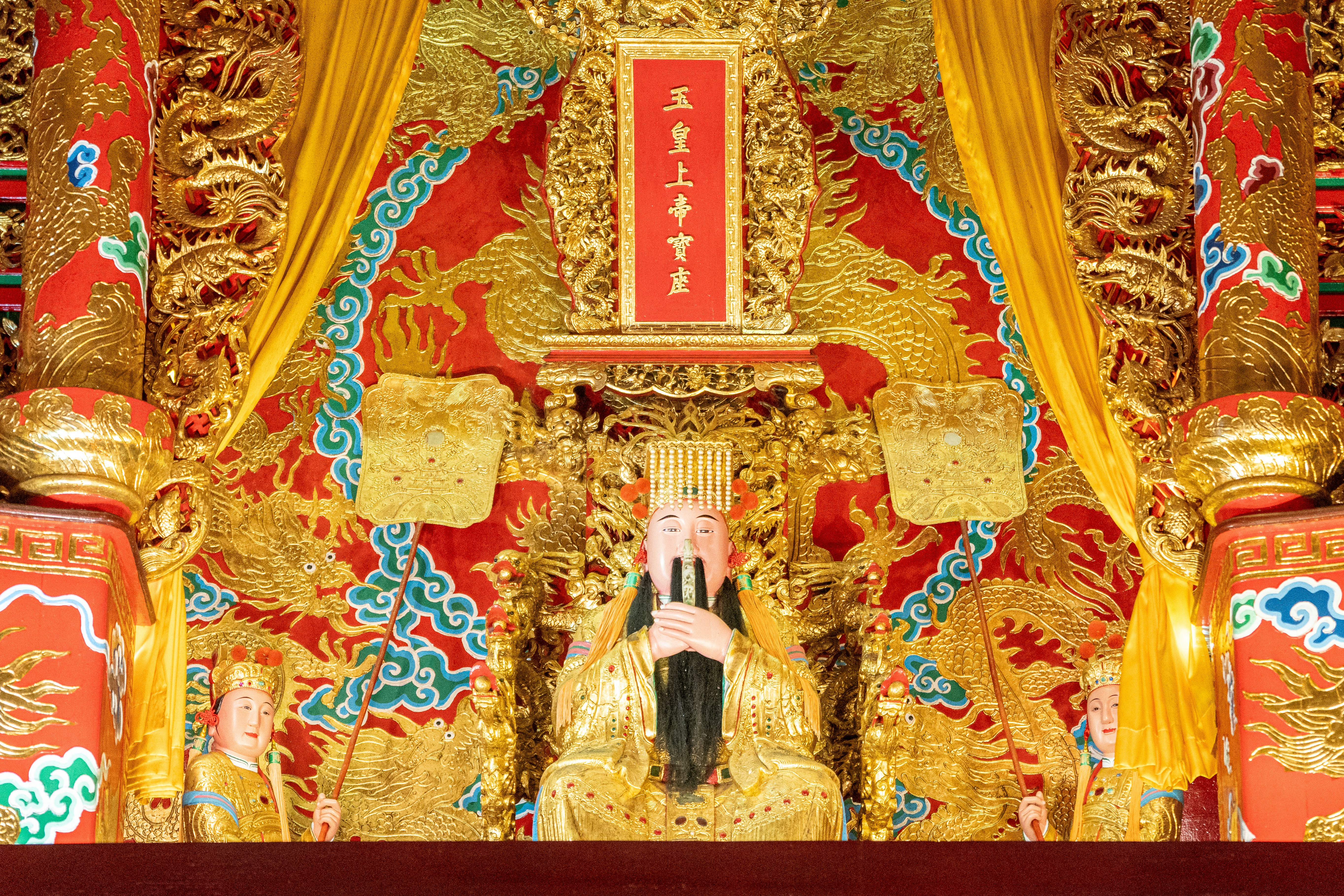 The Golden Throne: Sacred Central Figure Amid Dragon-embroidered Draperies
