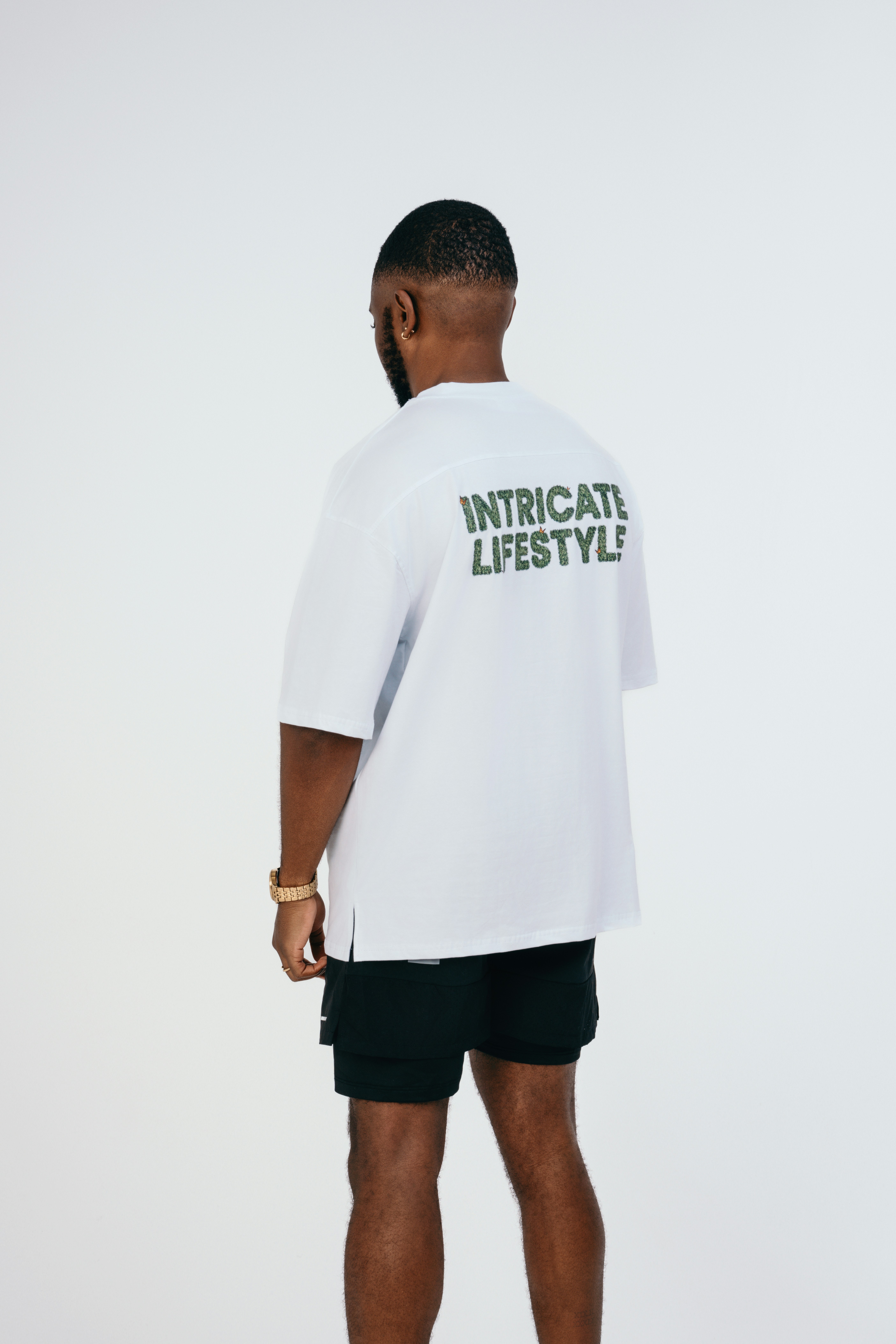 Back-View Portrait: Intricate Lifestyle Tee in a Minimal Studio