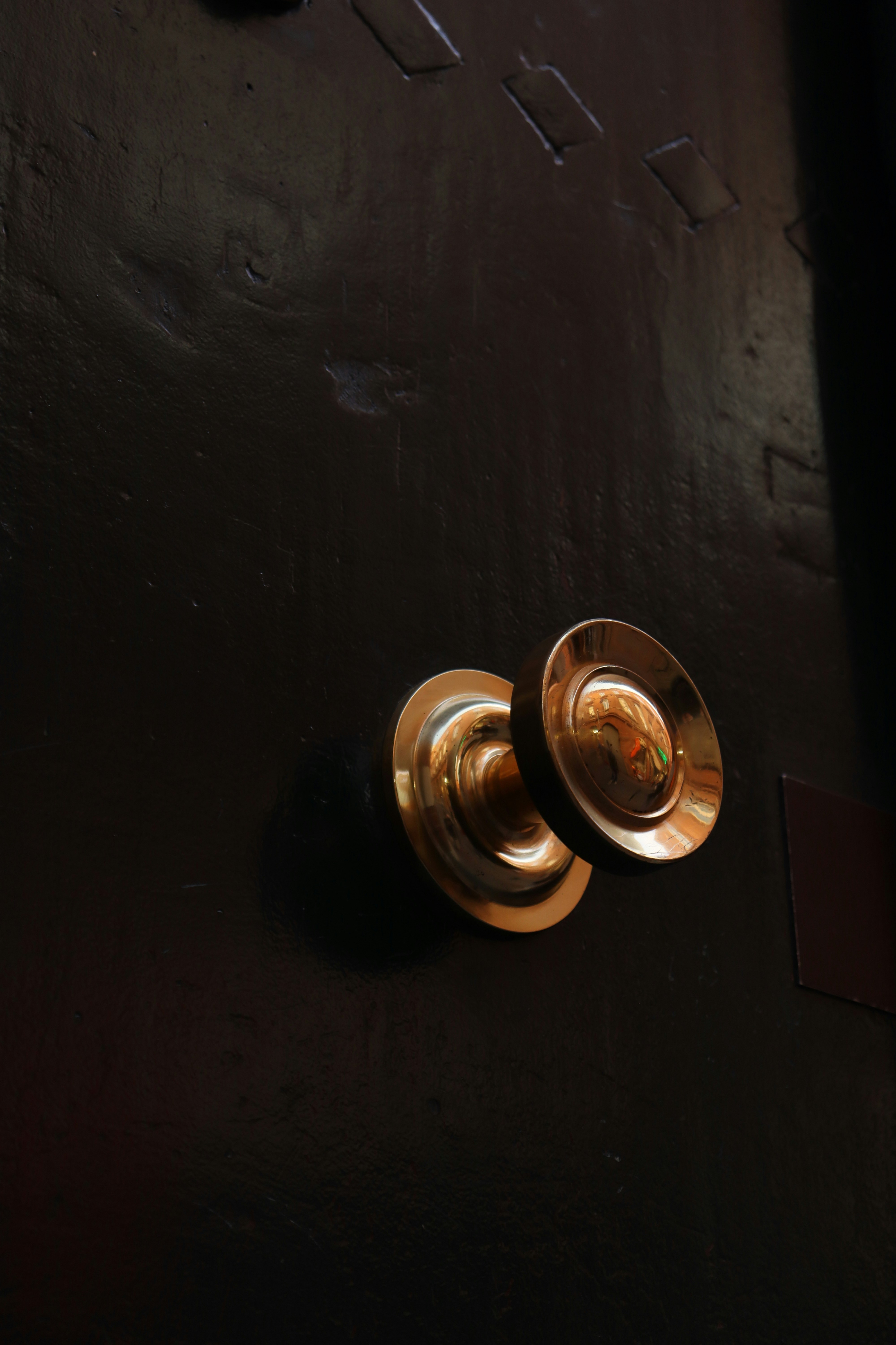 Brass Doorknob's Quiet Gleam in a Shadowed Hallway