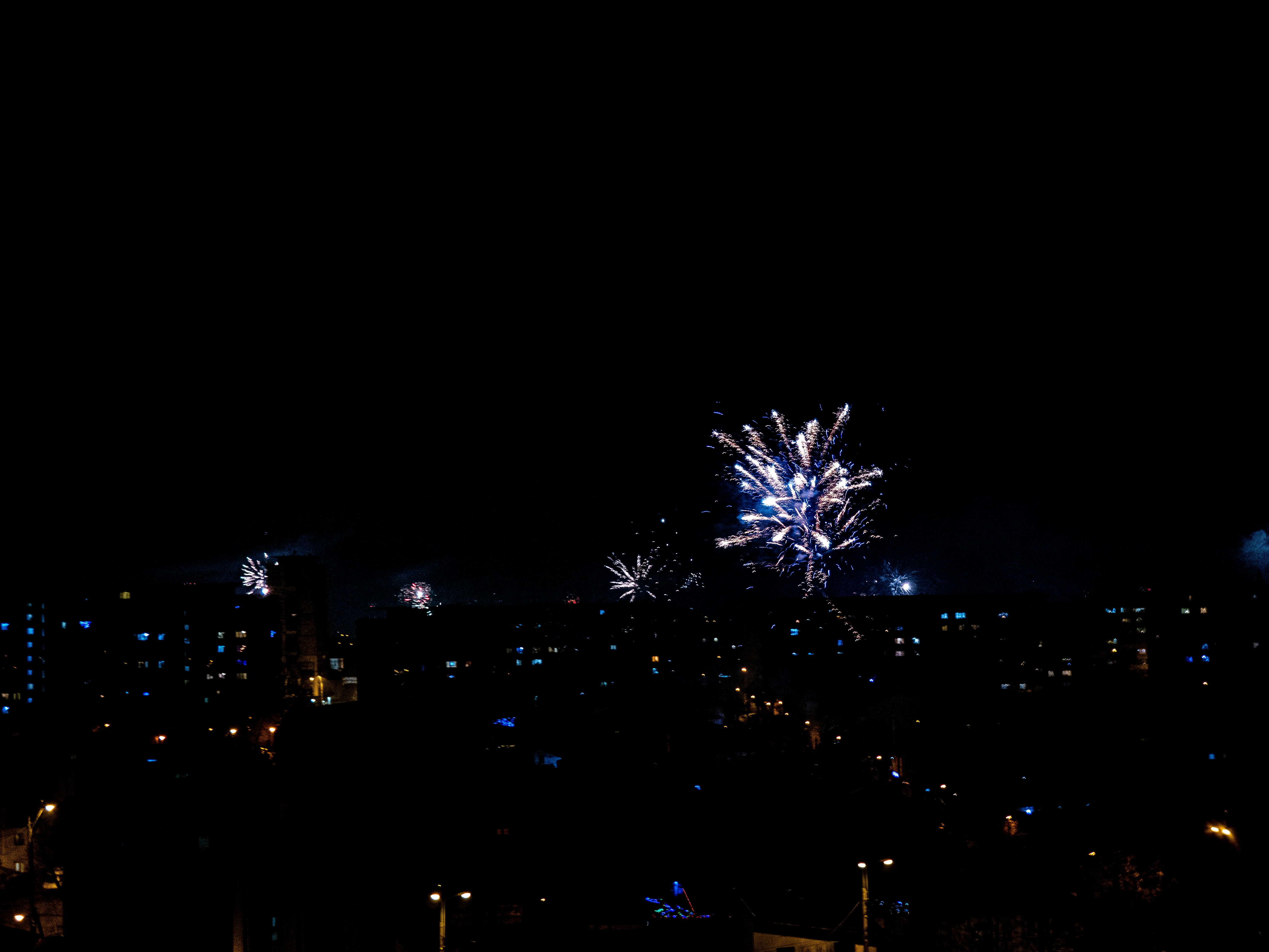 Nocturnal Celebration Over Urban Silhouettes