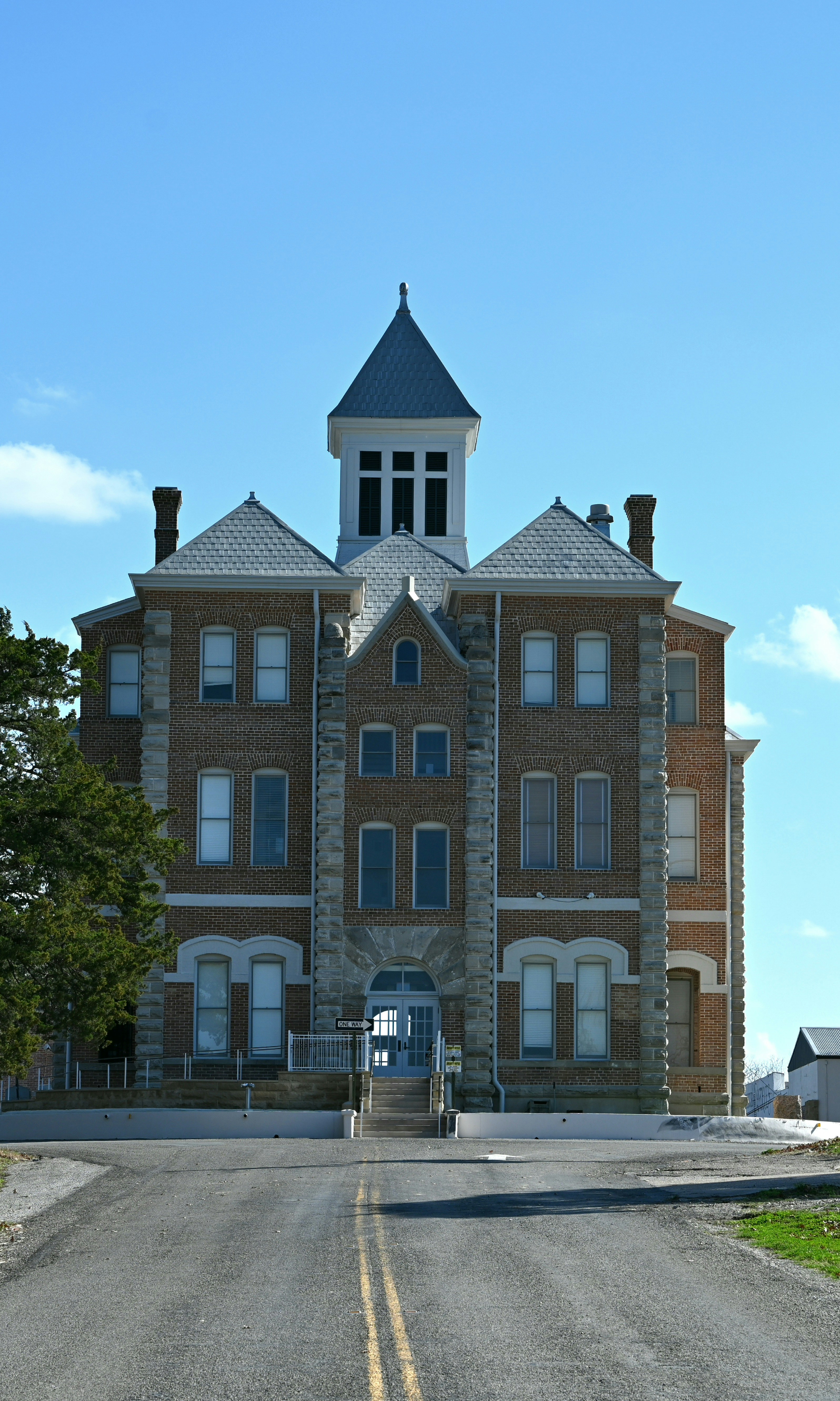 Brick-Gothic Manor on a Quiet Road: Central Tower Framed by Slate Roofs