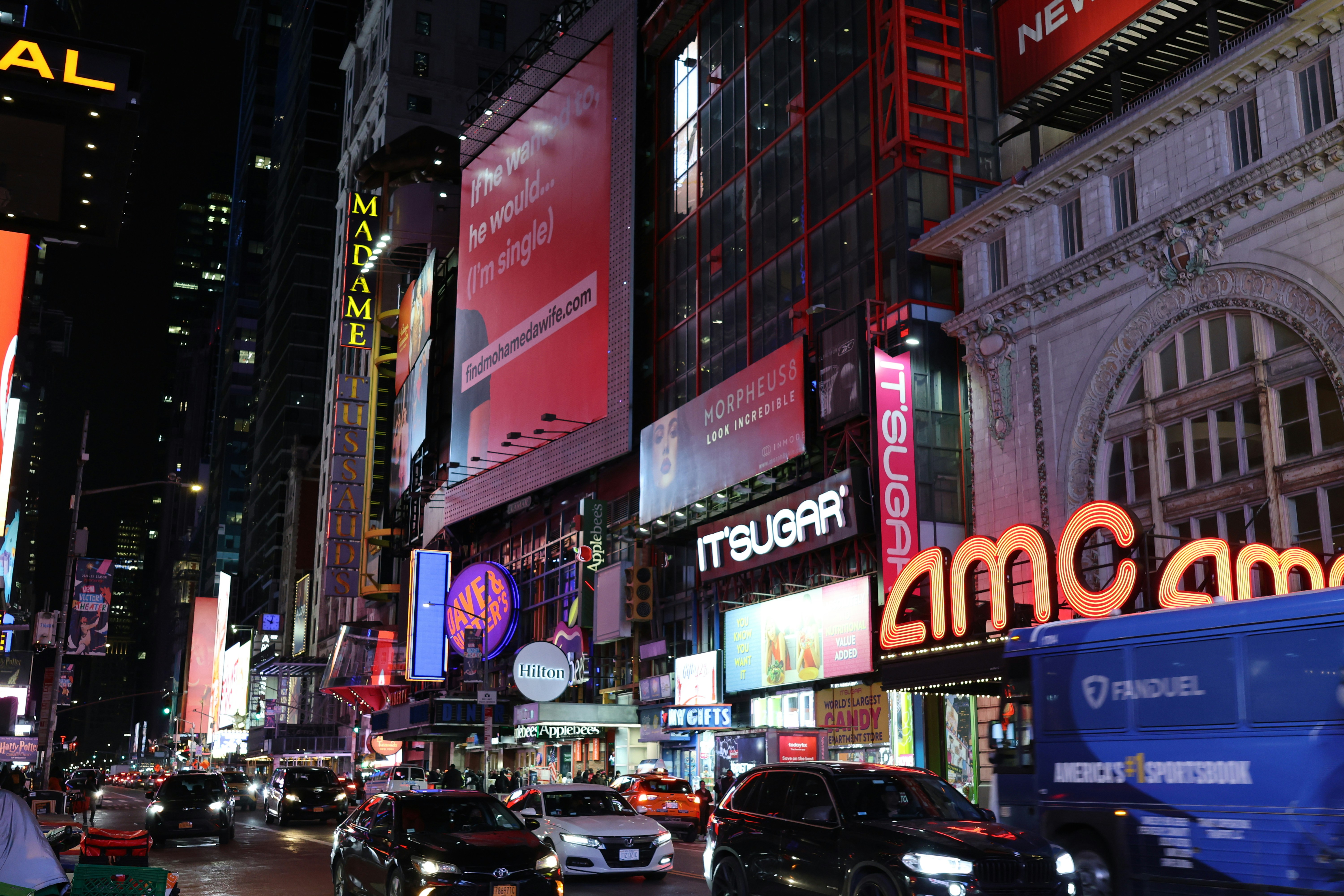 Bustling Times Square with vibrant neon lights and colorful billboards illuminating the night.
