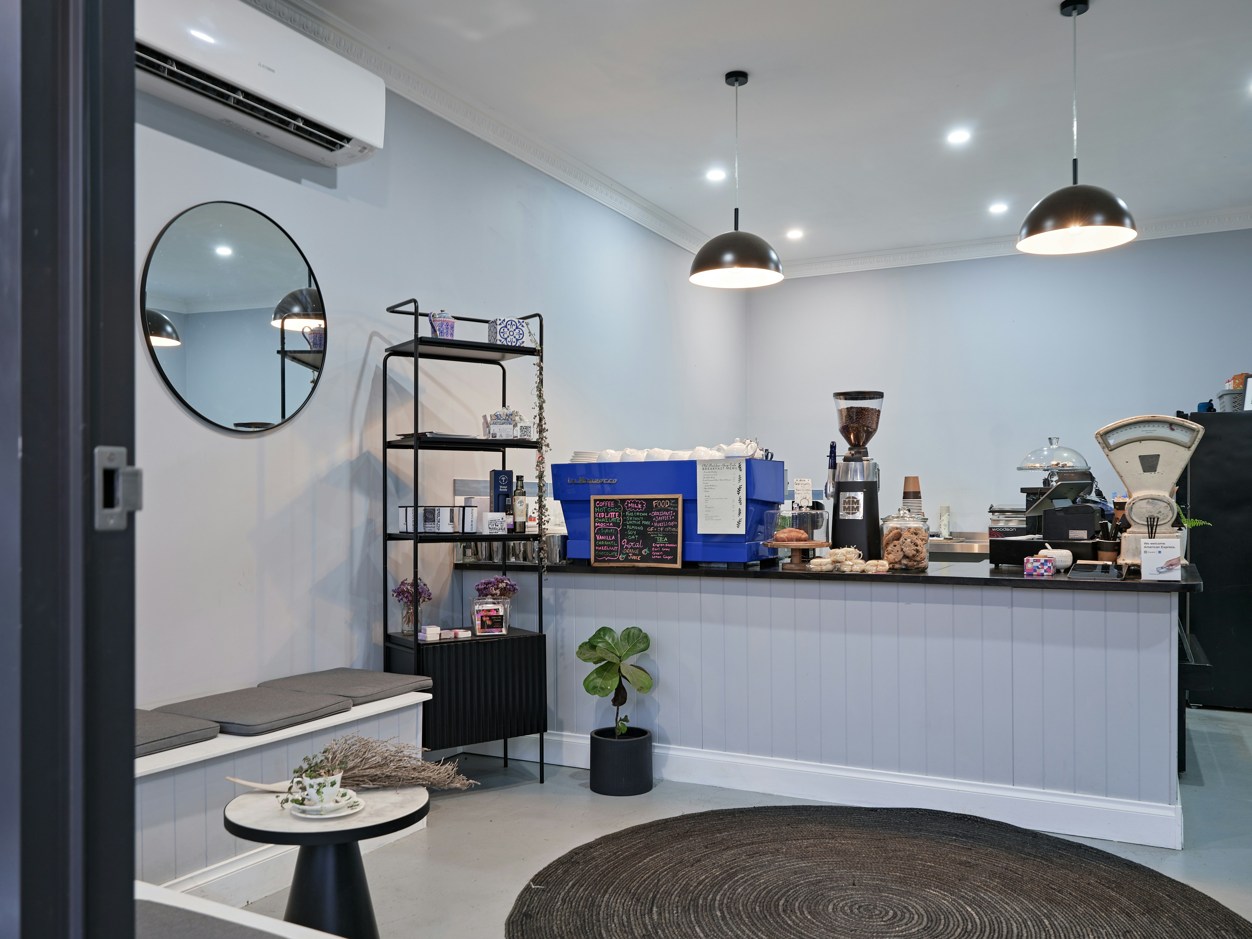 A coffee shop with a large ottoman in the middle of the room photo ...