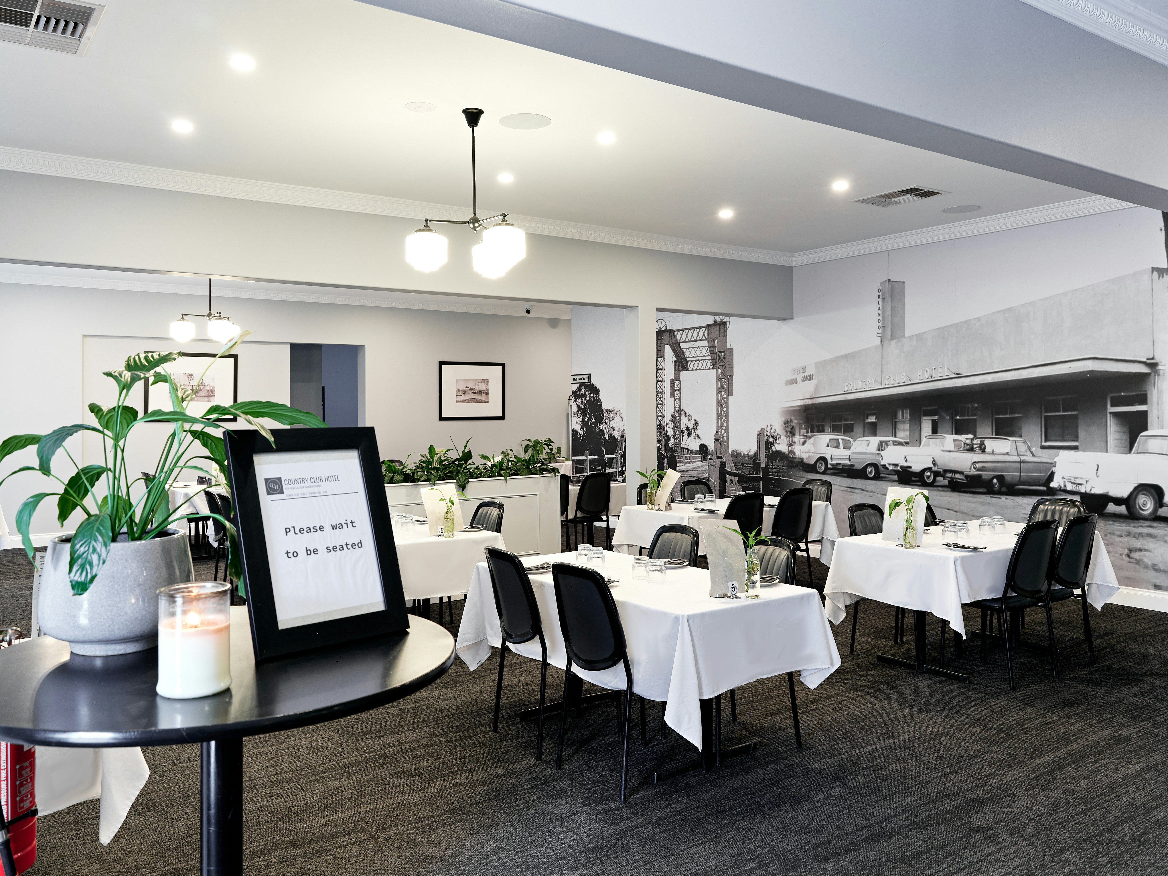 A restaurant with tables, chairs, and pictures on the wall photo – Free ...