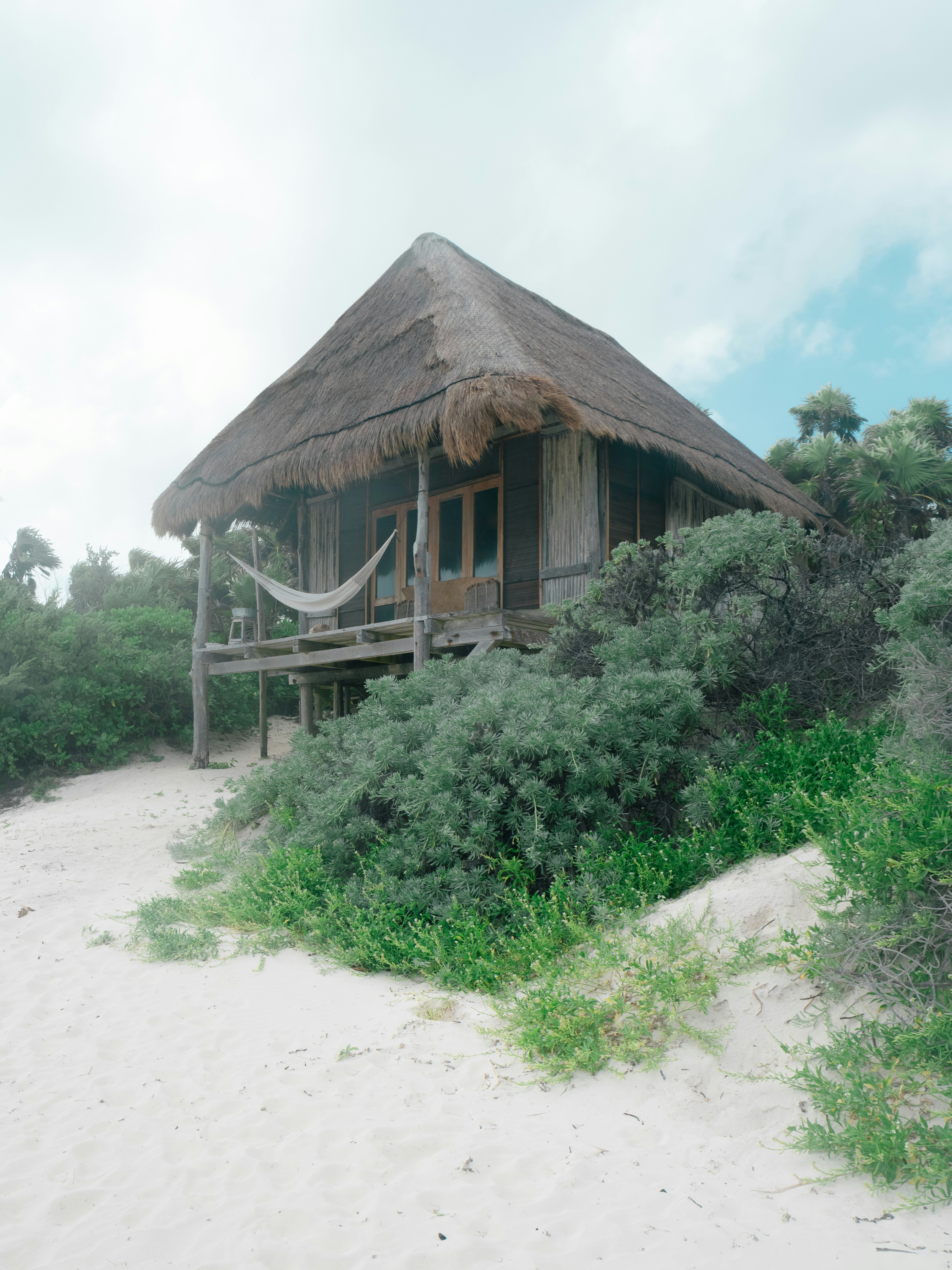 Thatched Beach Hut on Stilts, Hammock on the Deck Over Powdery Sand