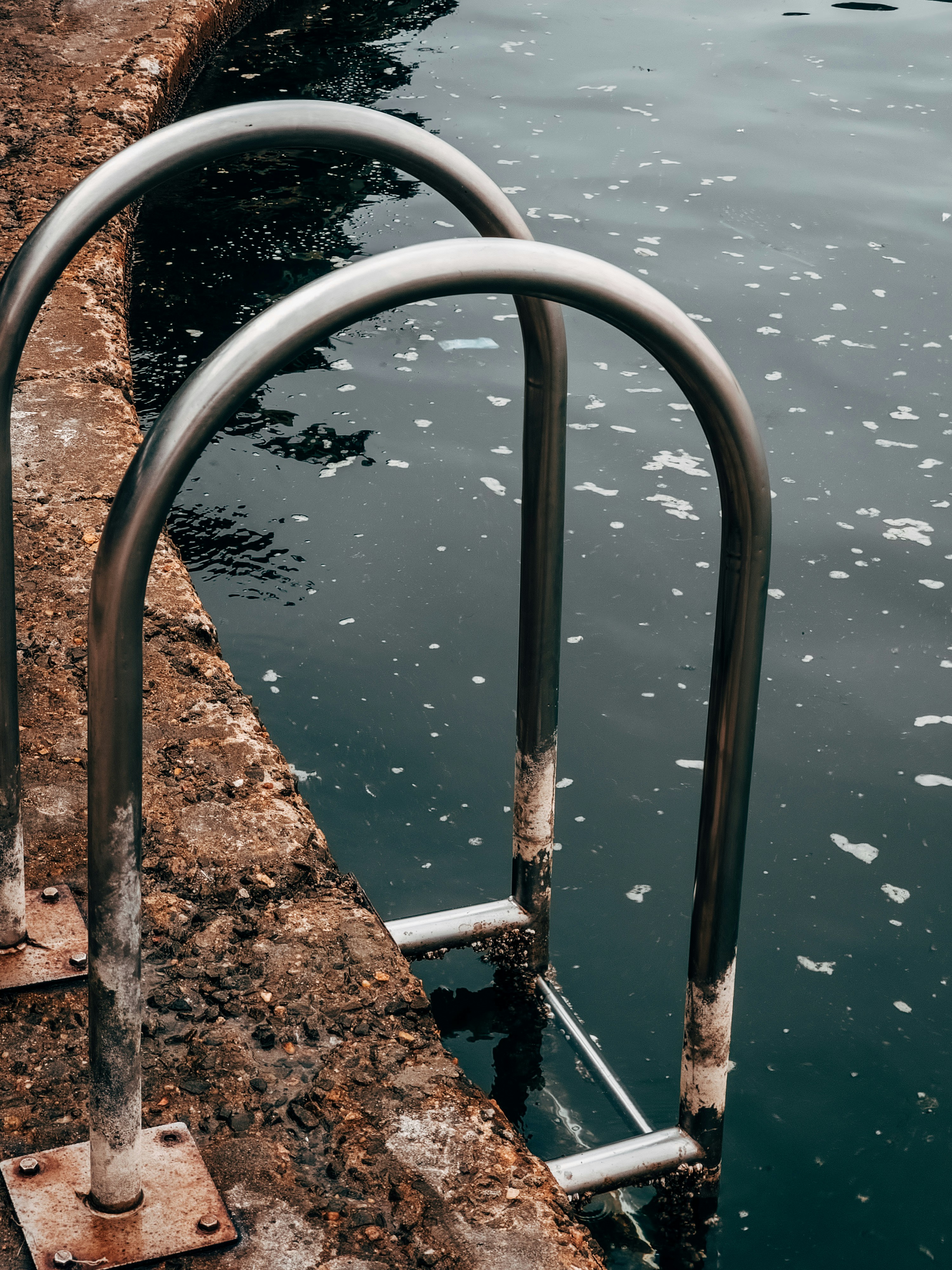 Curved Dock Rails Reaching Into Quiet Water
