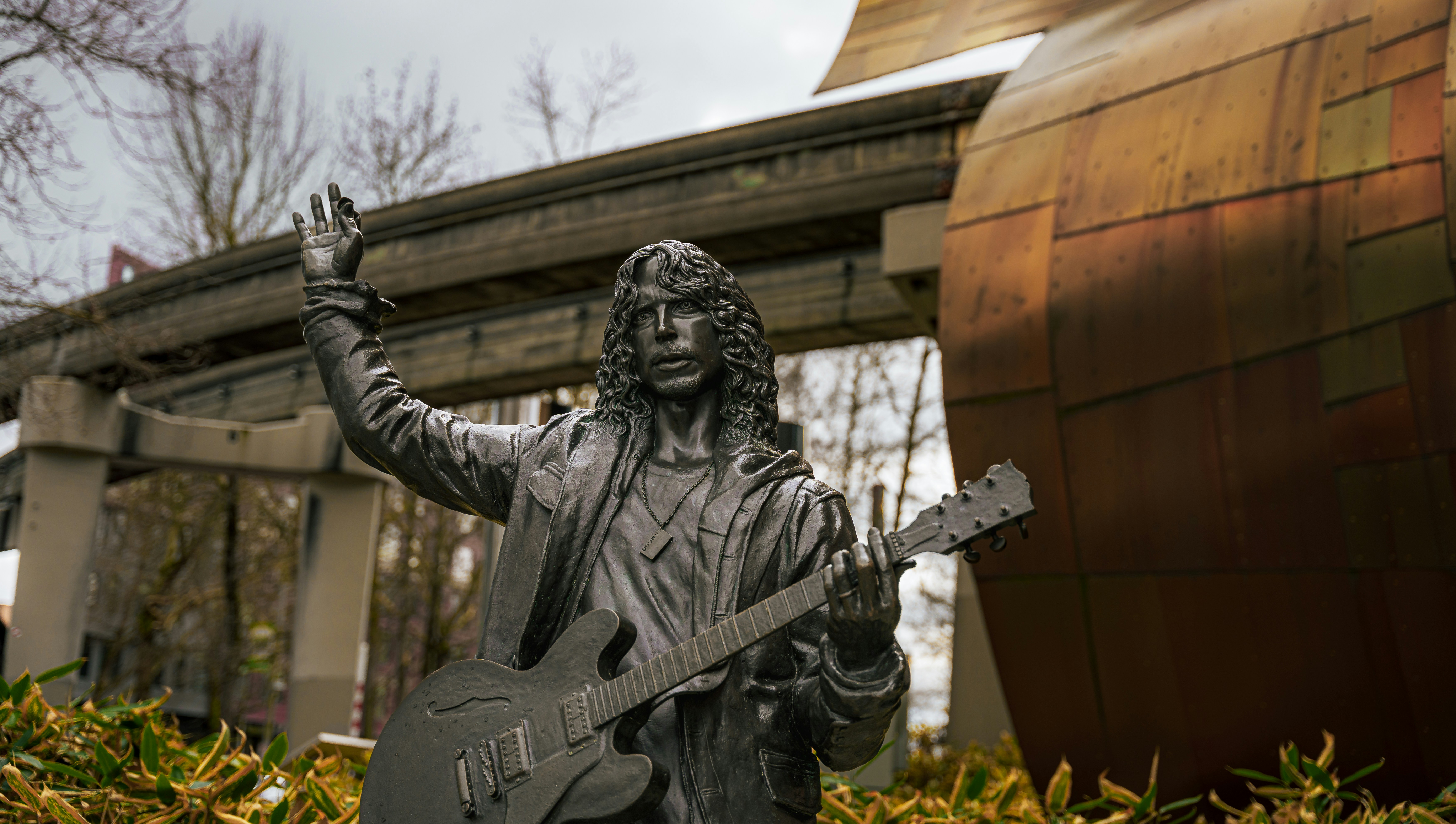 Raised Hand, Silent Riff: A Bronze Guitarist in the Park