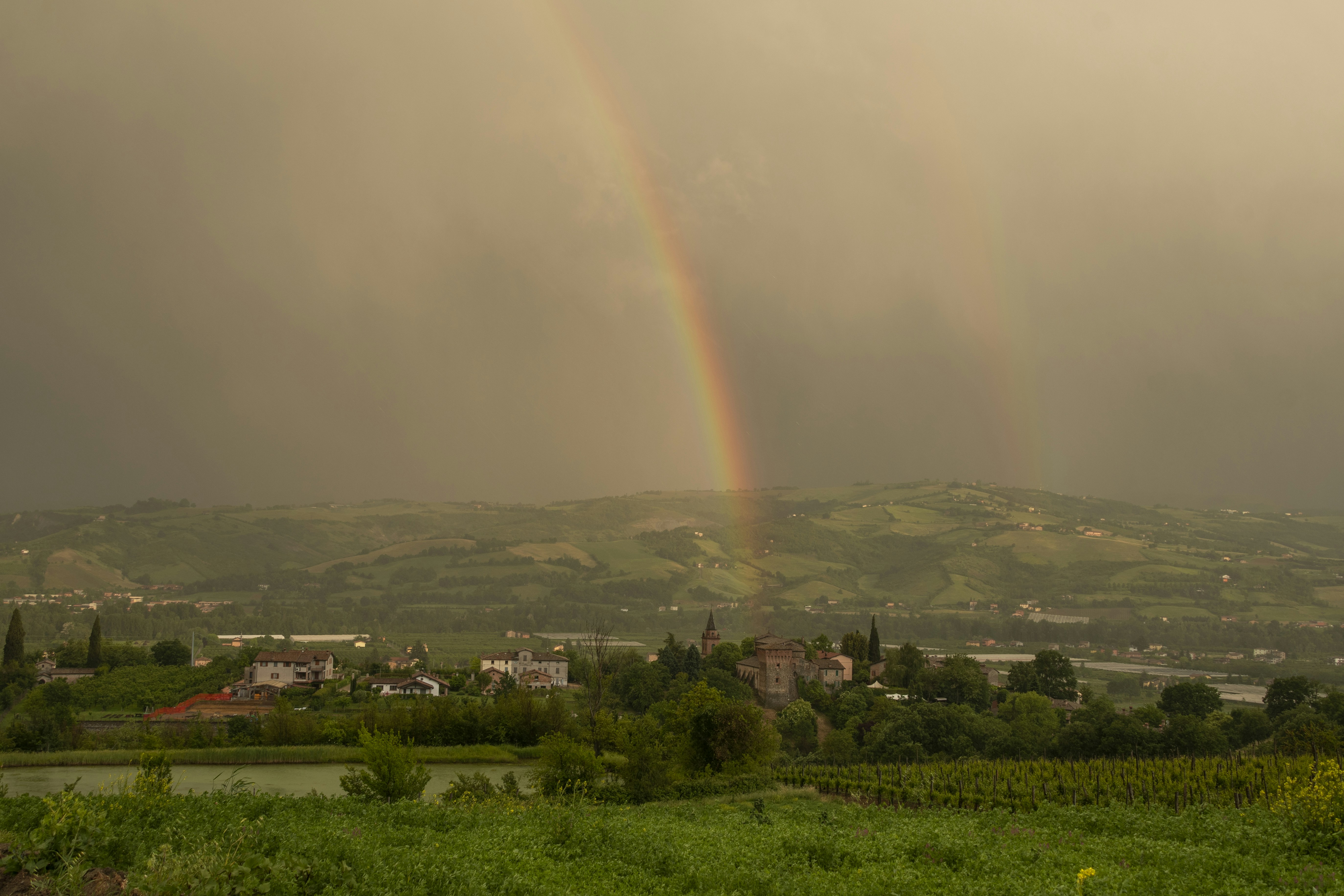 Rainbow's Embrace Over the Hills