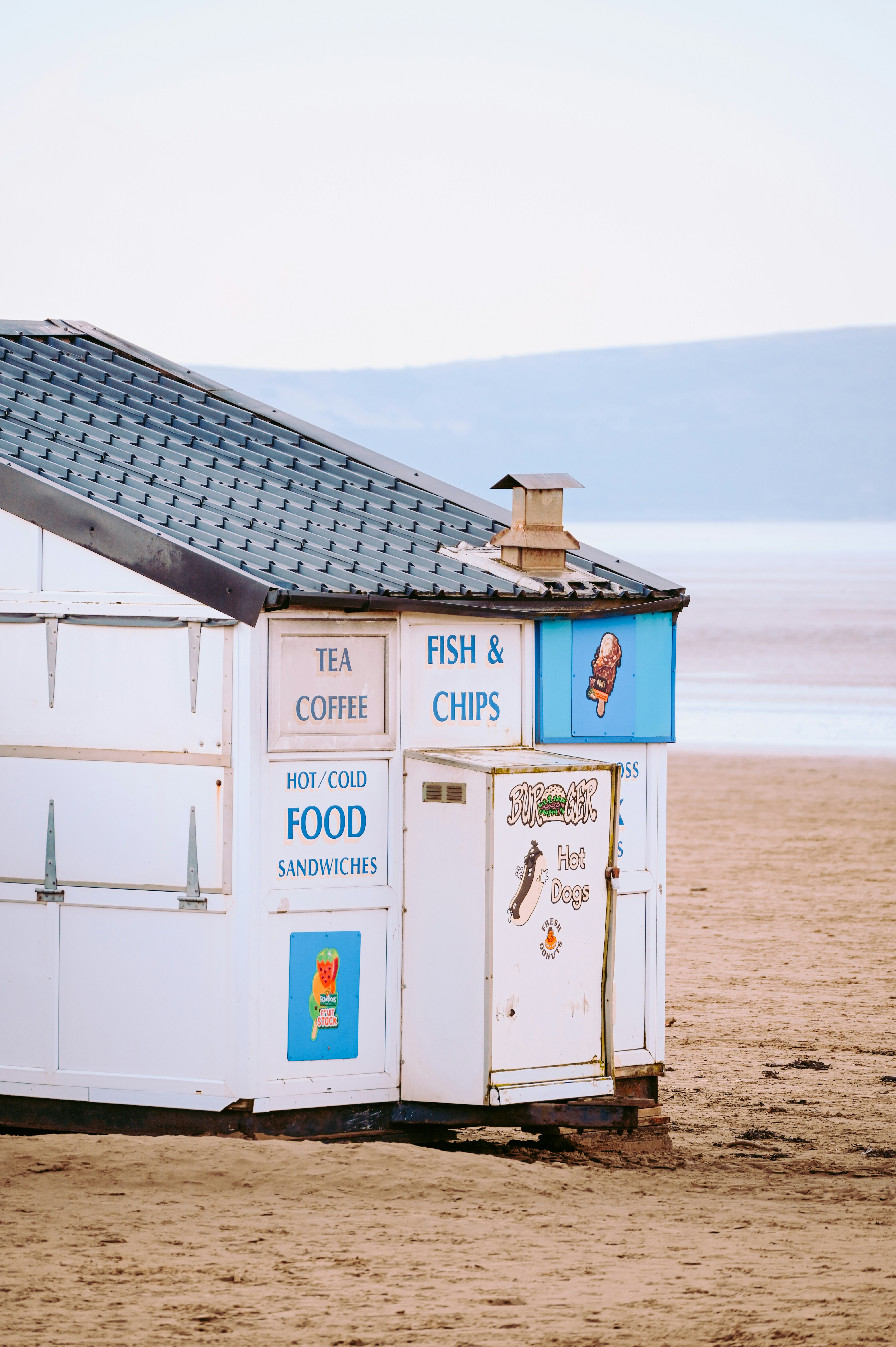 Pastel Beach Snack Hut with Fish & Chips Sign by the Quiet Sea