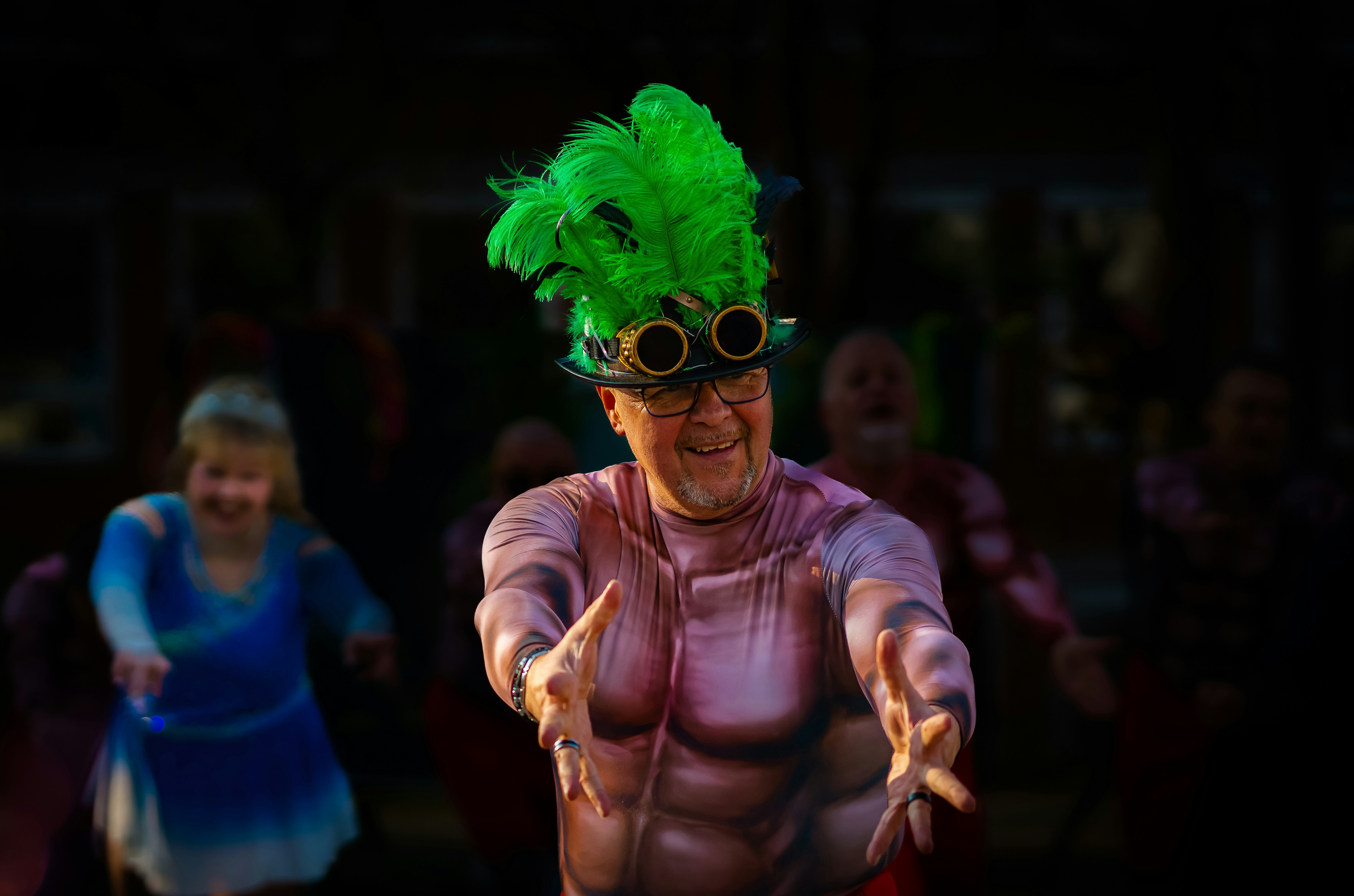 Emerald Plume Dancer Reaches Forward in Neon Purple Bodysuit