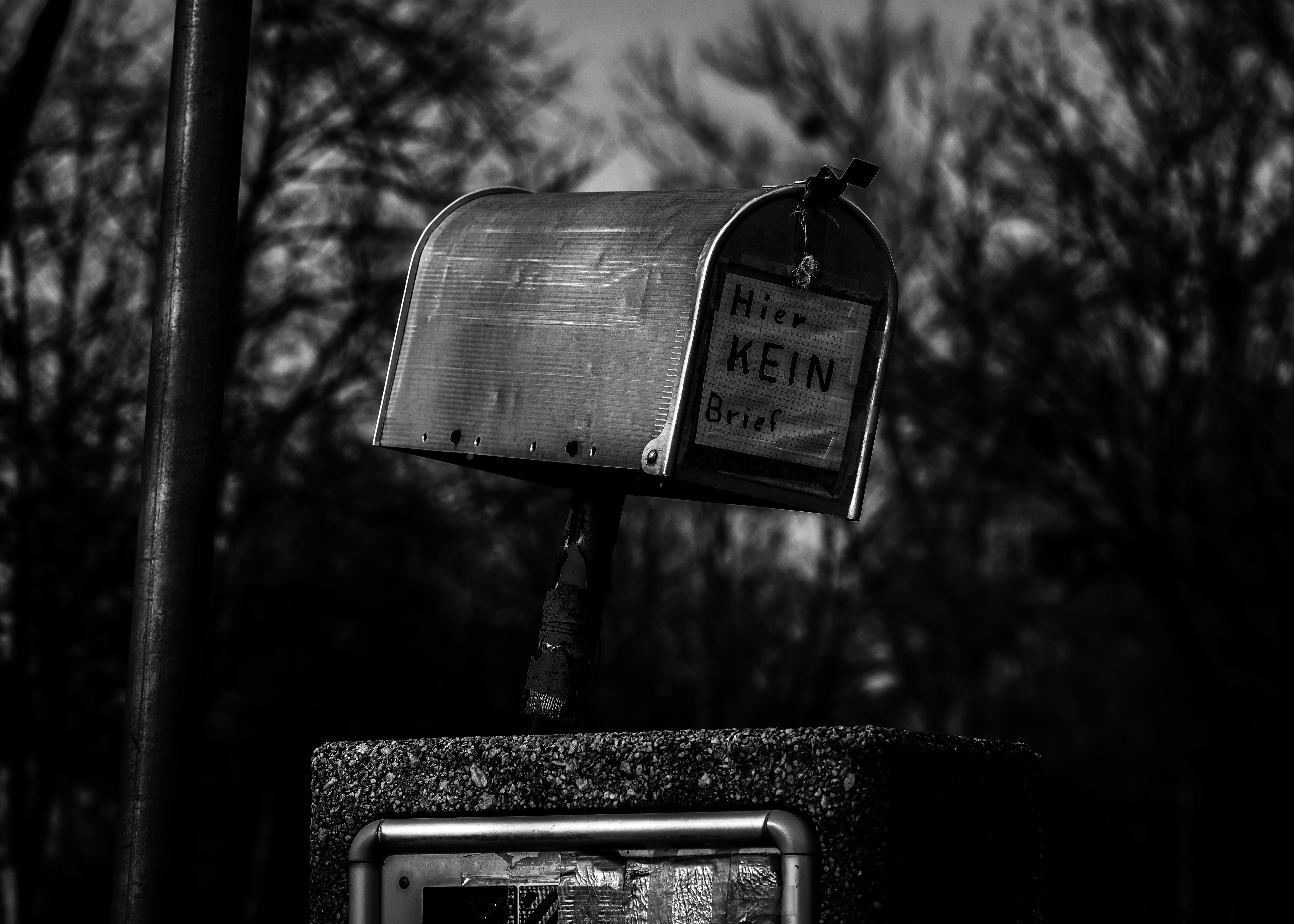 A black and white photo of a mailbox