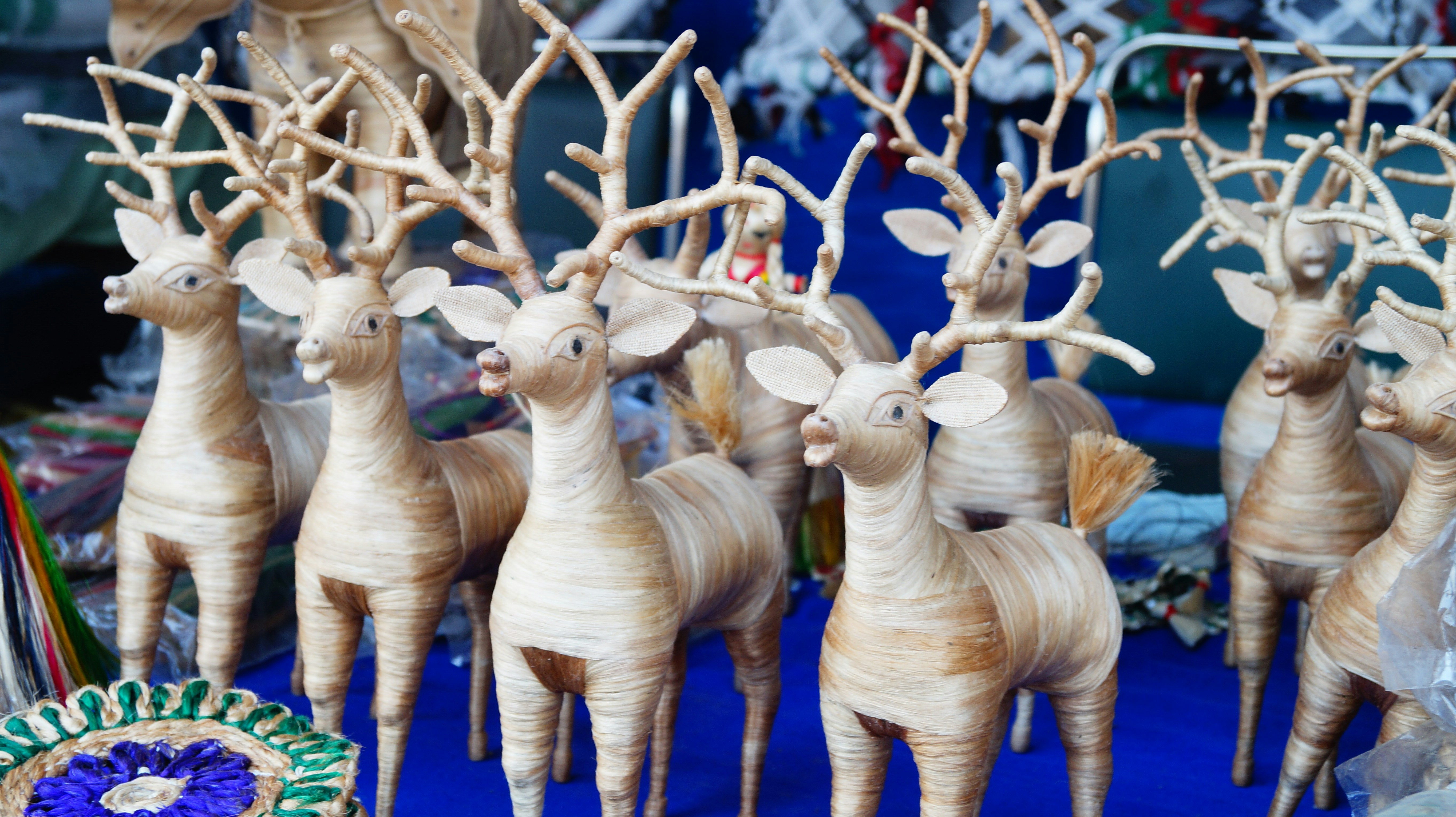 A group of wooden deer figurines on a table