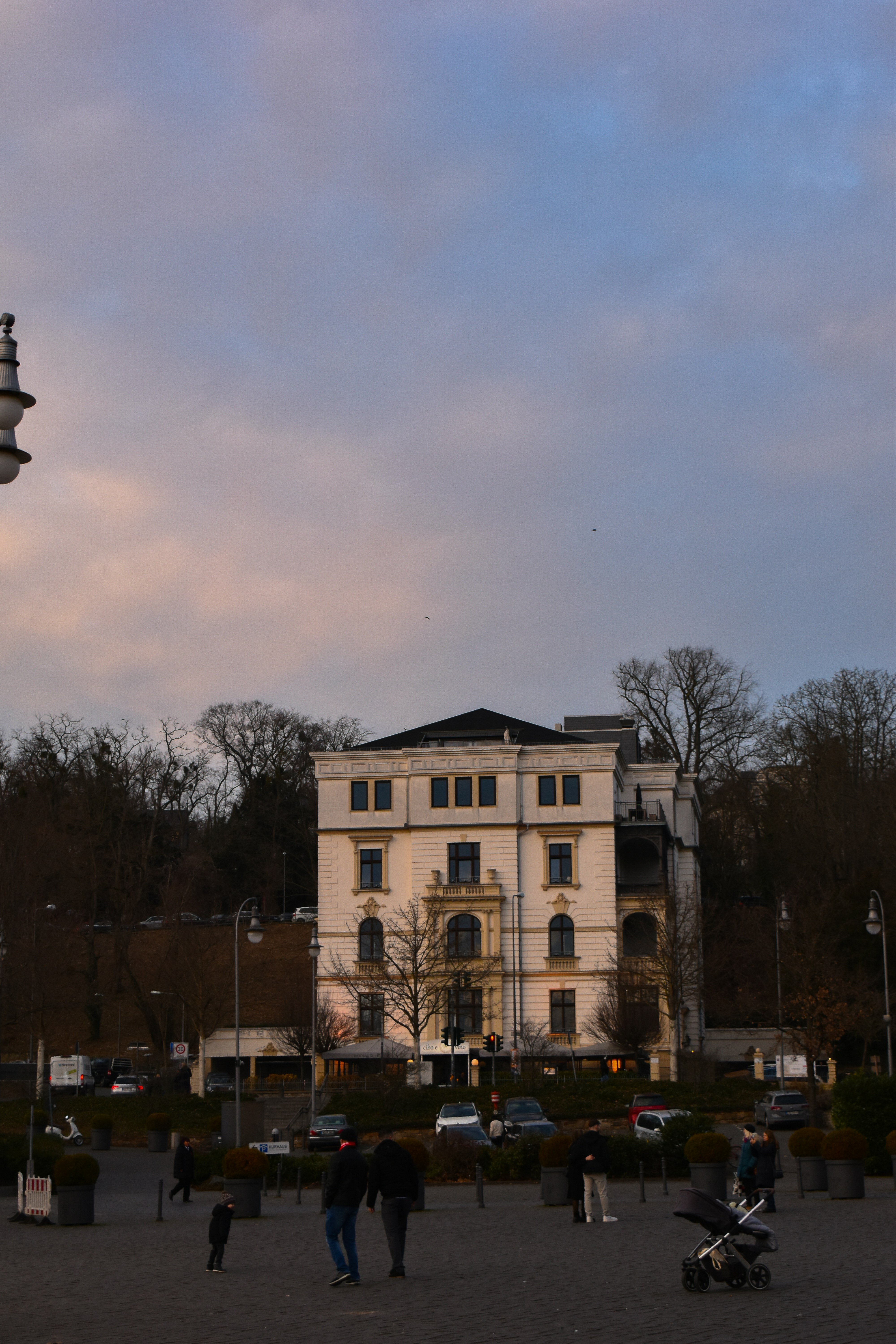 Twilight in the Square: A Stately White Facade Amid Quiet Urban Dusk