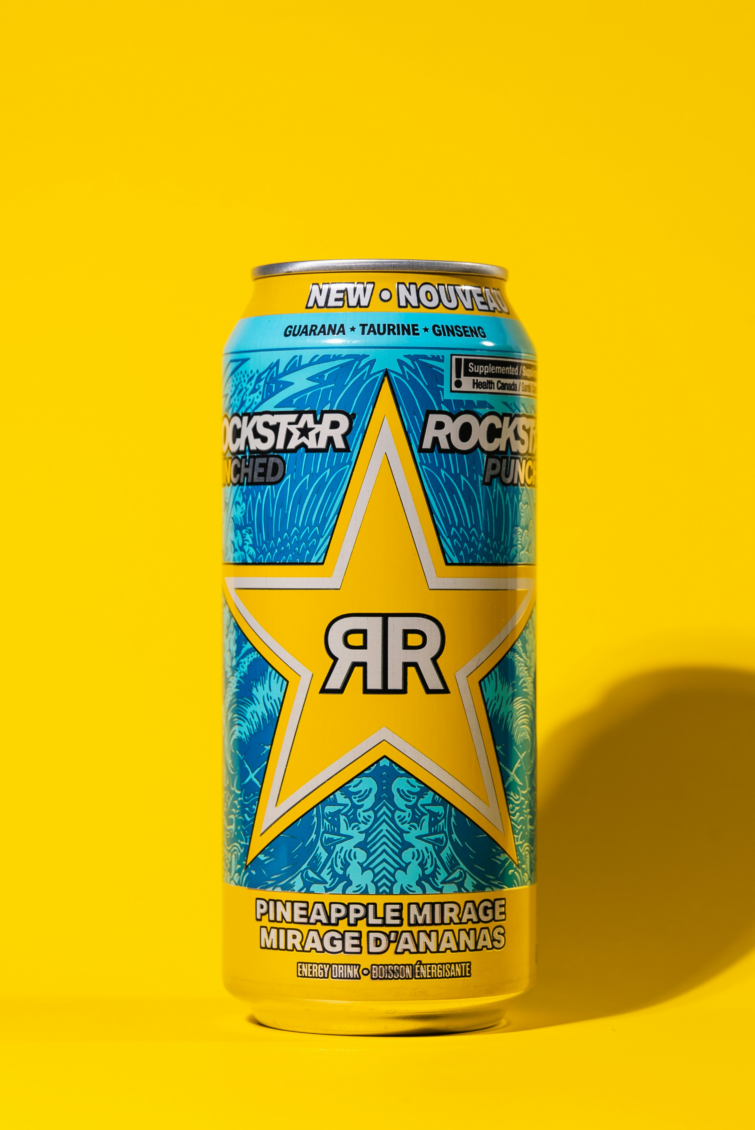 Pineapple Mirage on a Yellow Stage: A Rockstar Energy Can in Focus